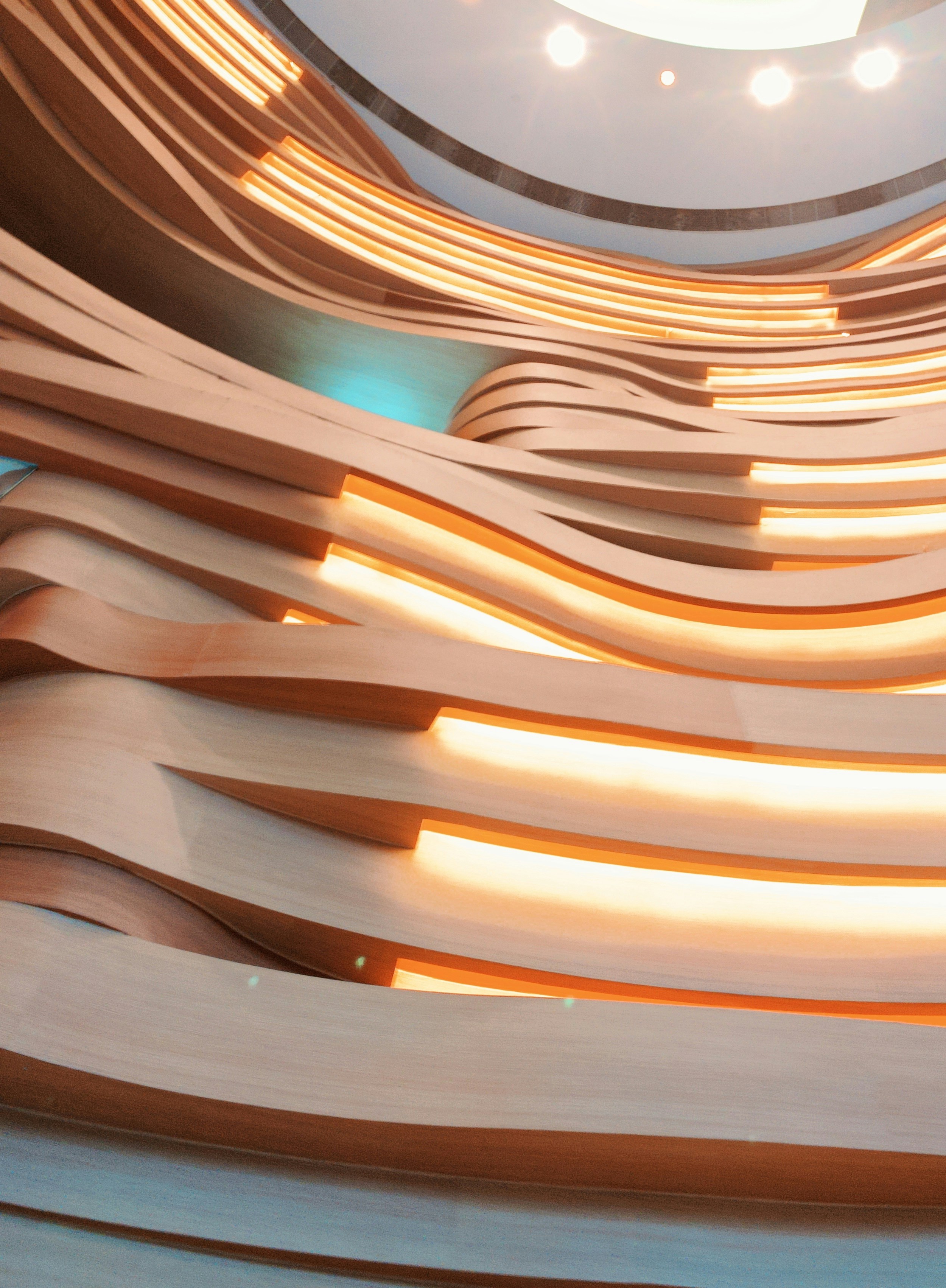 A curved wooden structure with lights on the ceiling photo – Free Hong ...