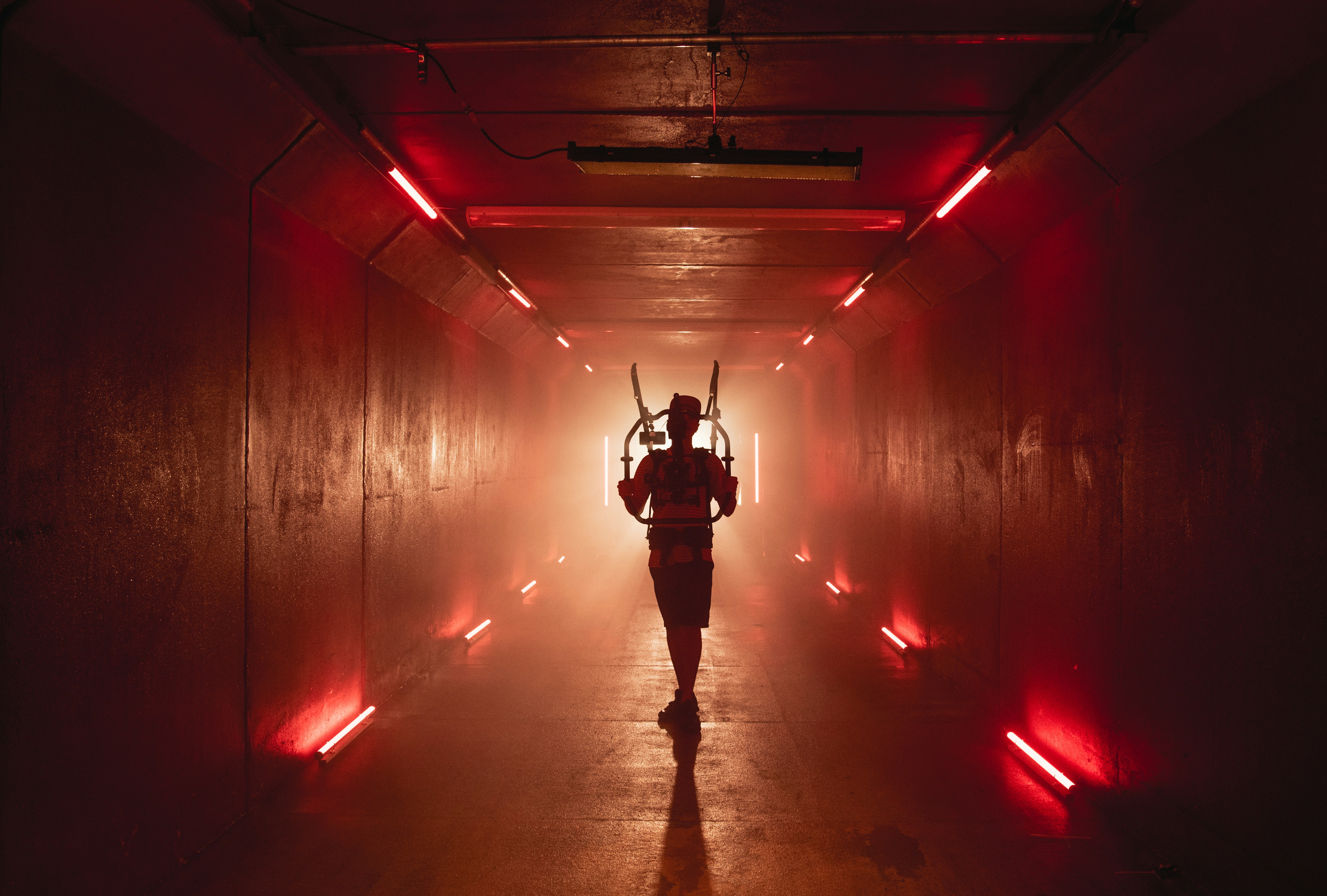 Crimson Corridor: A Lone Silhouette Walks Toward the Neon End