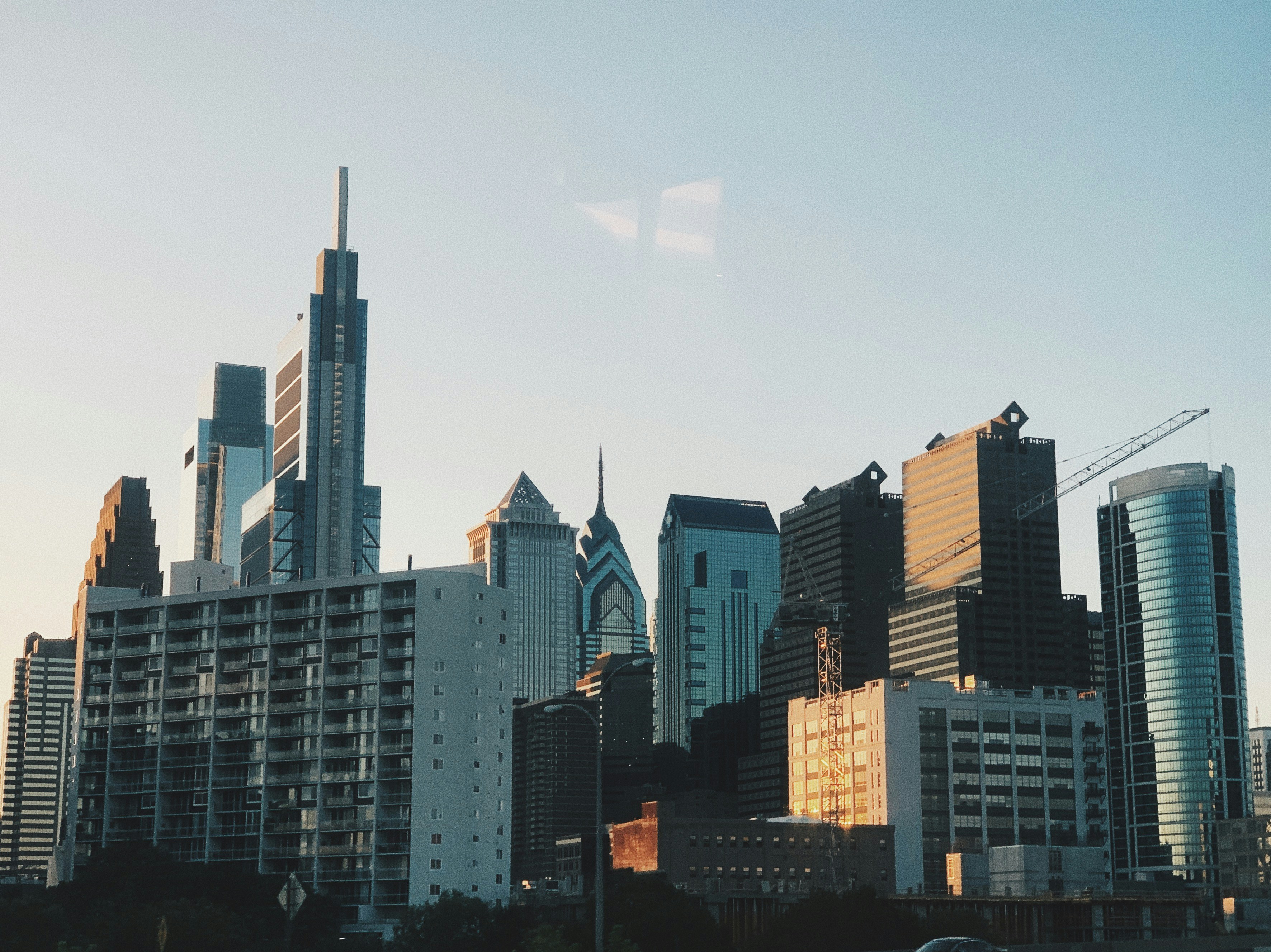 Skyline of modern skyscrapers against a clear evening sky.