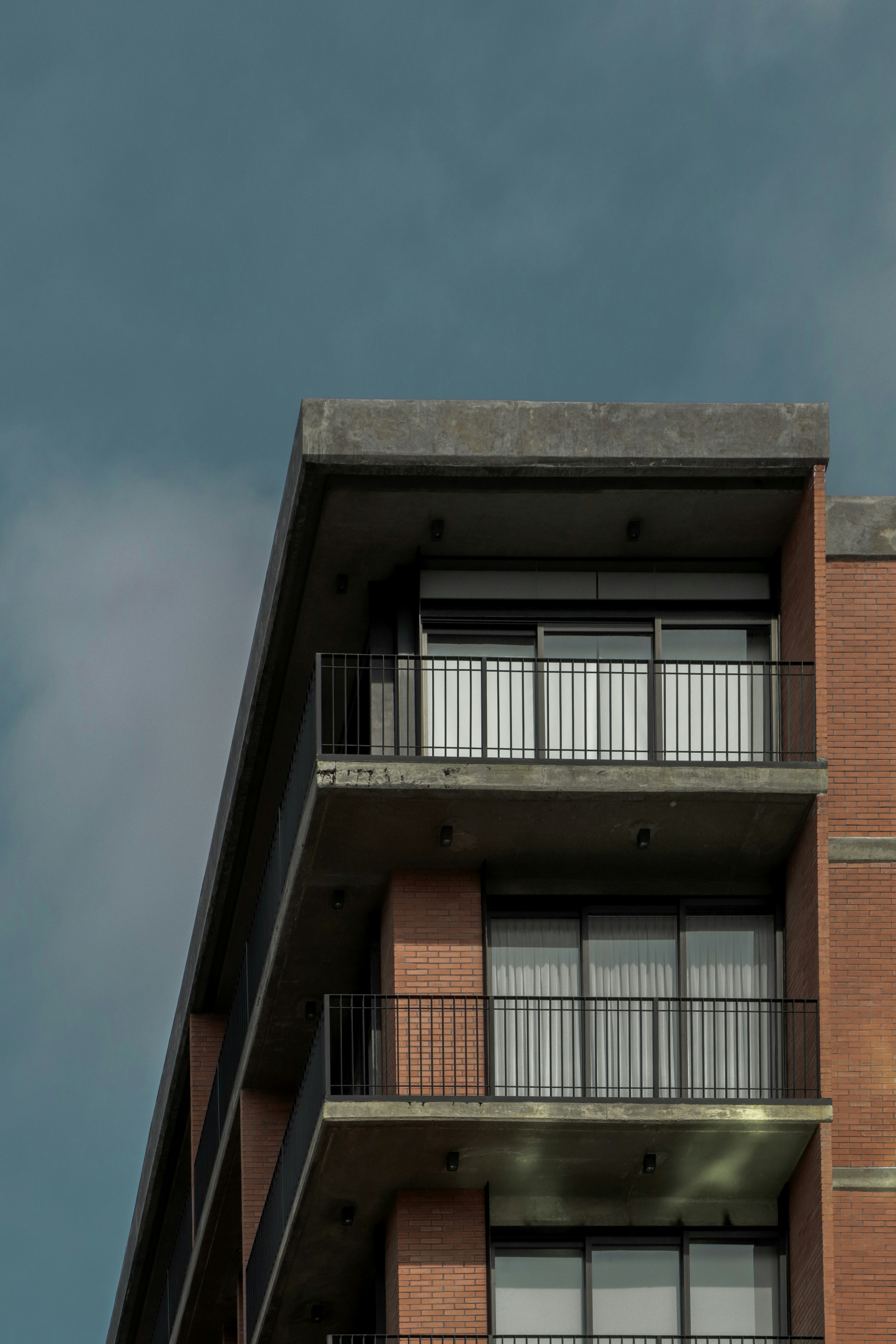Red and gray high rise building under clear sky photo – Free Balcony ...