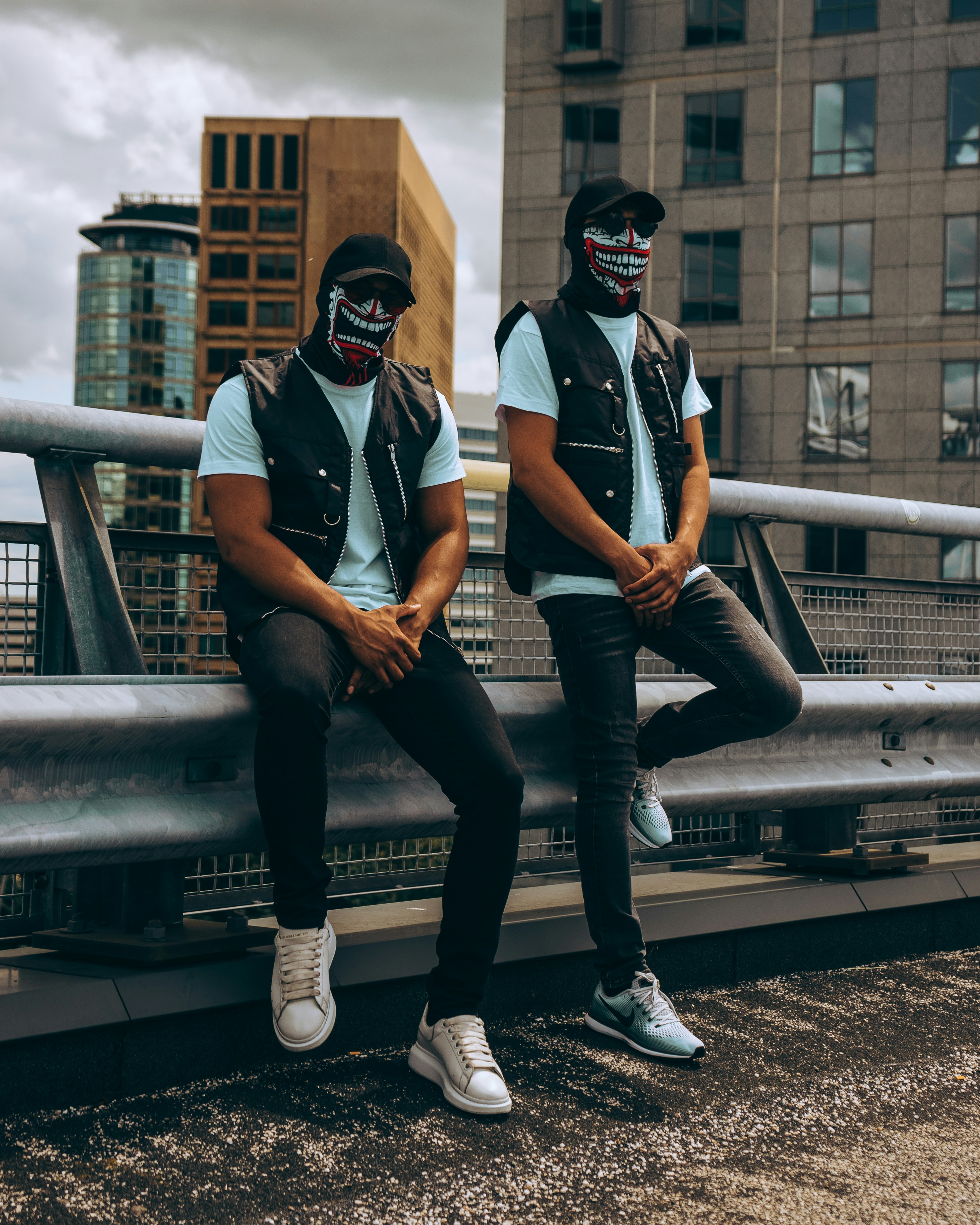Rooftop Grin: Two Masked Figures Against a Cityscape