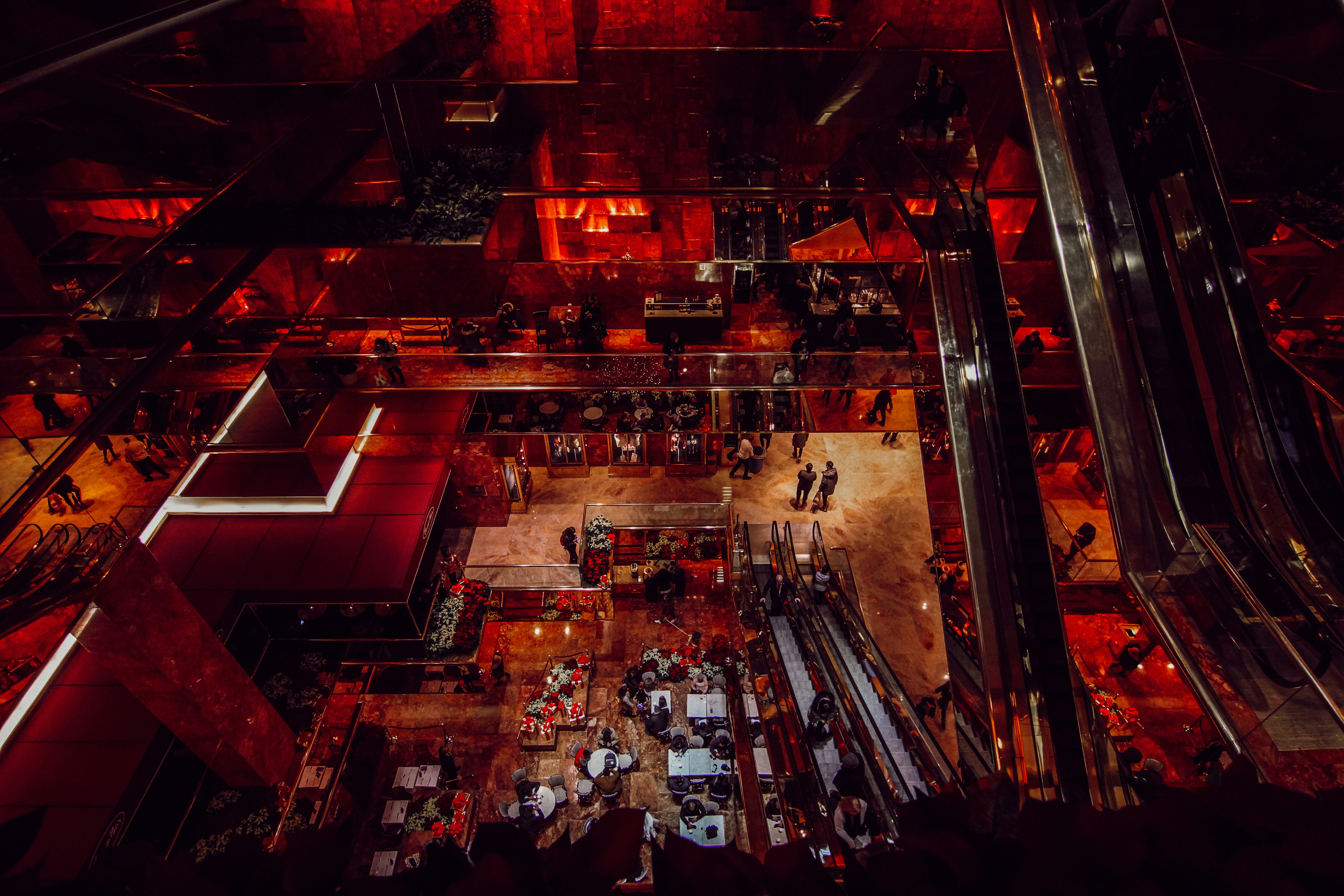 A vibrant interior scene showcasing a bustling space with reflective surfaces and warm lighting, highlighting the dynamic atmosphere of the venue.