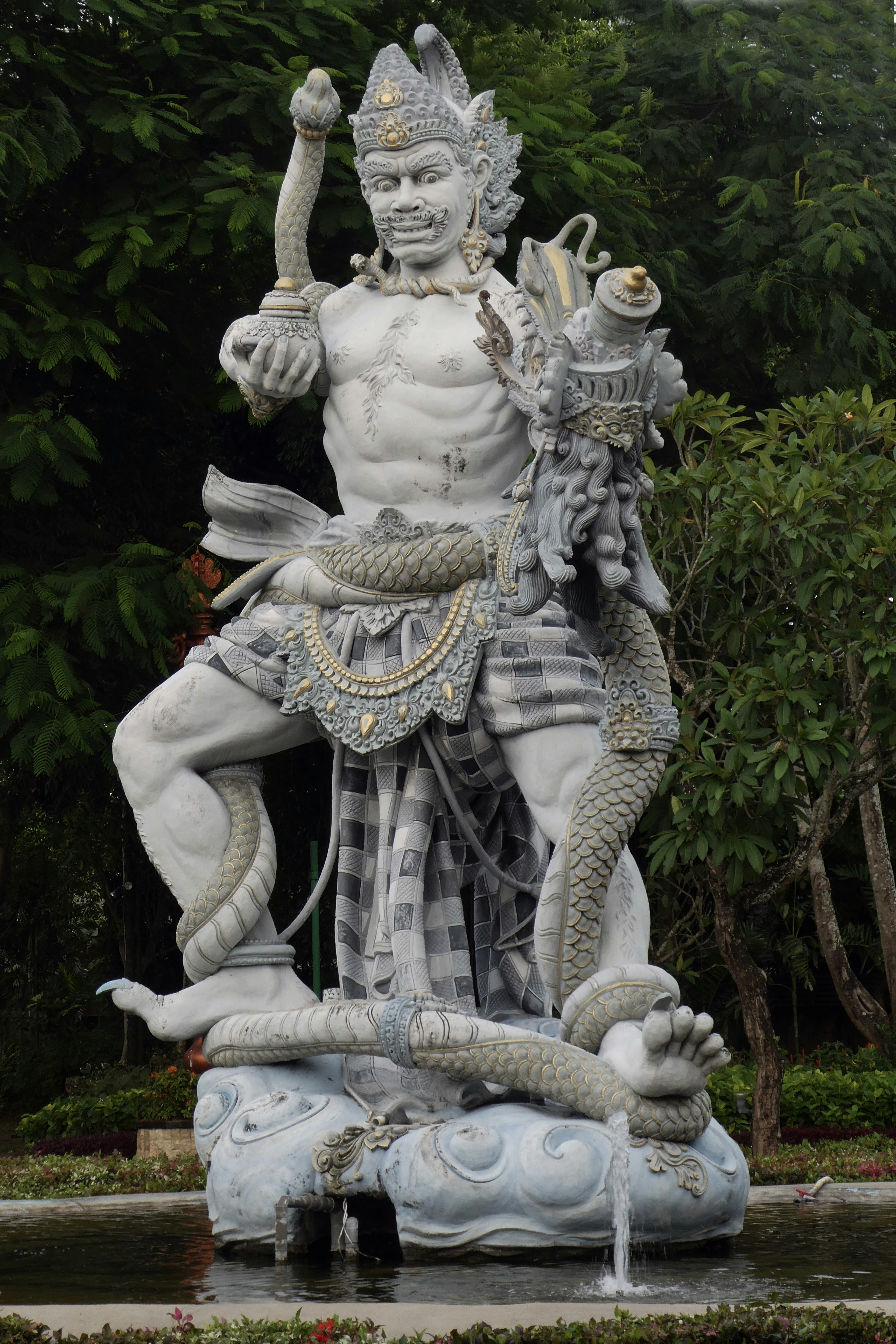 Majestic statue of a mythical figure, showcasing intricate details and a commanding presence, surrounded by lush greenery.