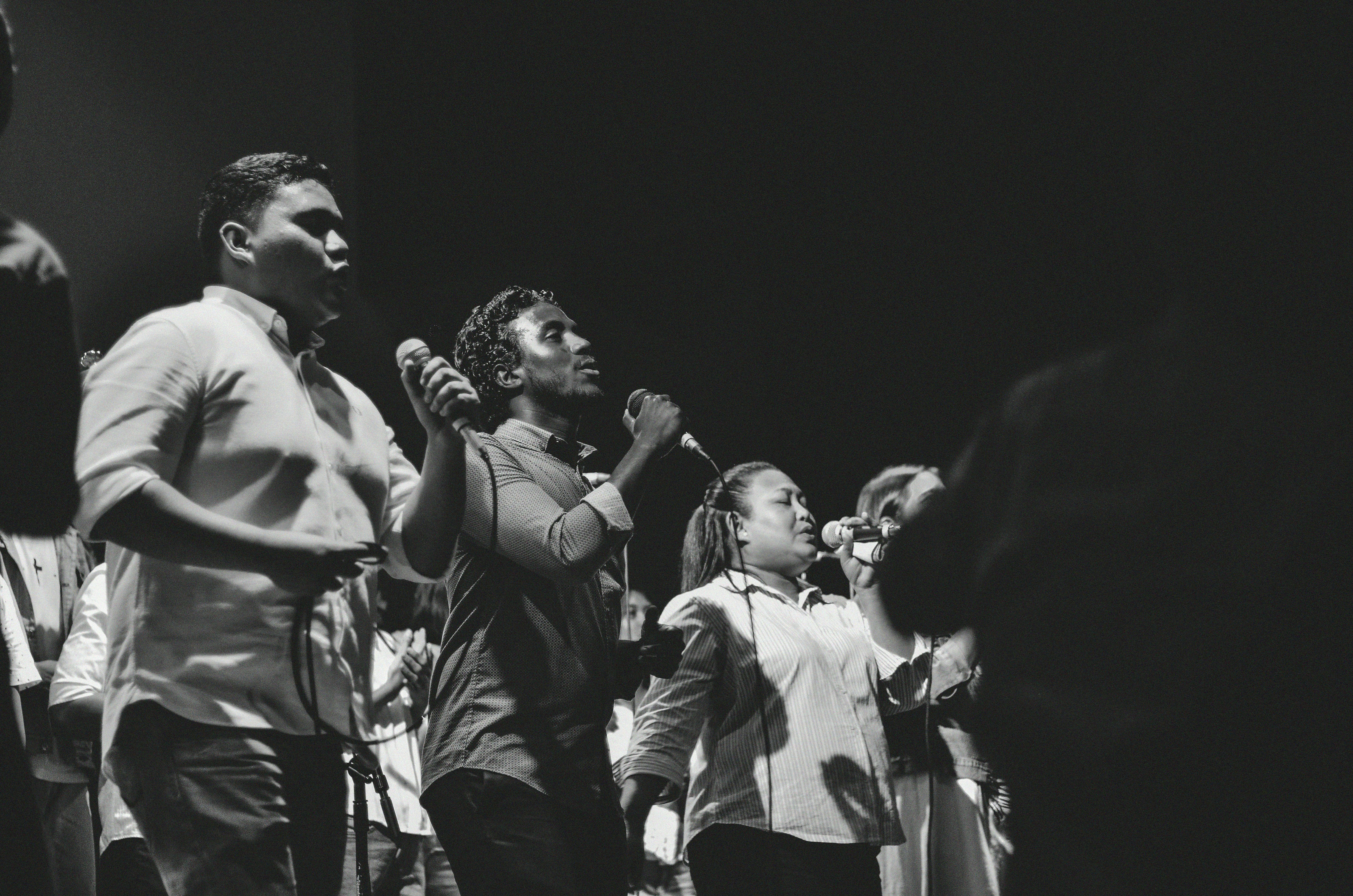 A black and white photo of a group of people singing photo – Free Human ...