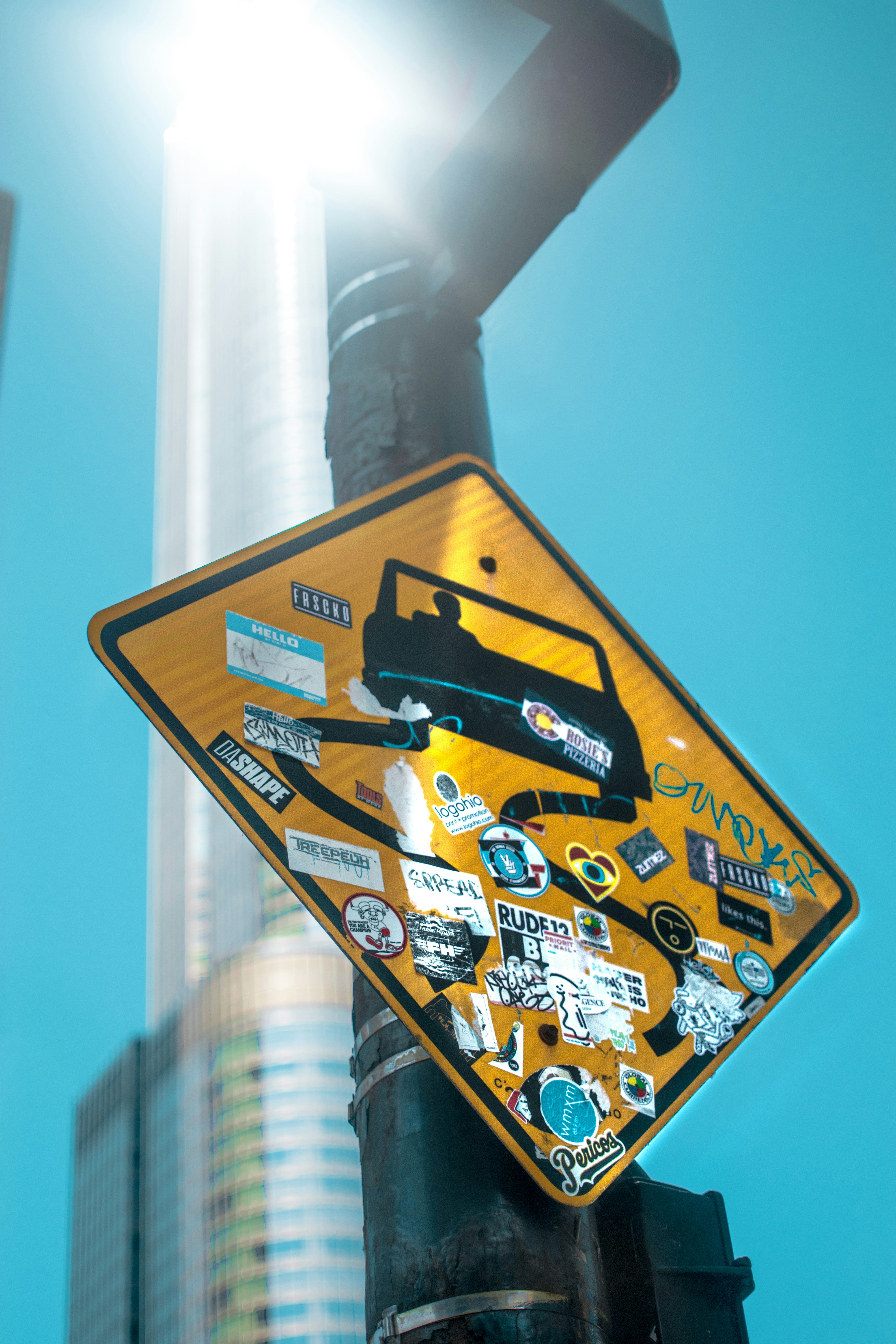 Curve road ahead signage with stickers photo – Free Sign Image on Unsplash