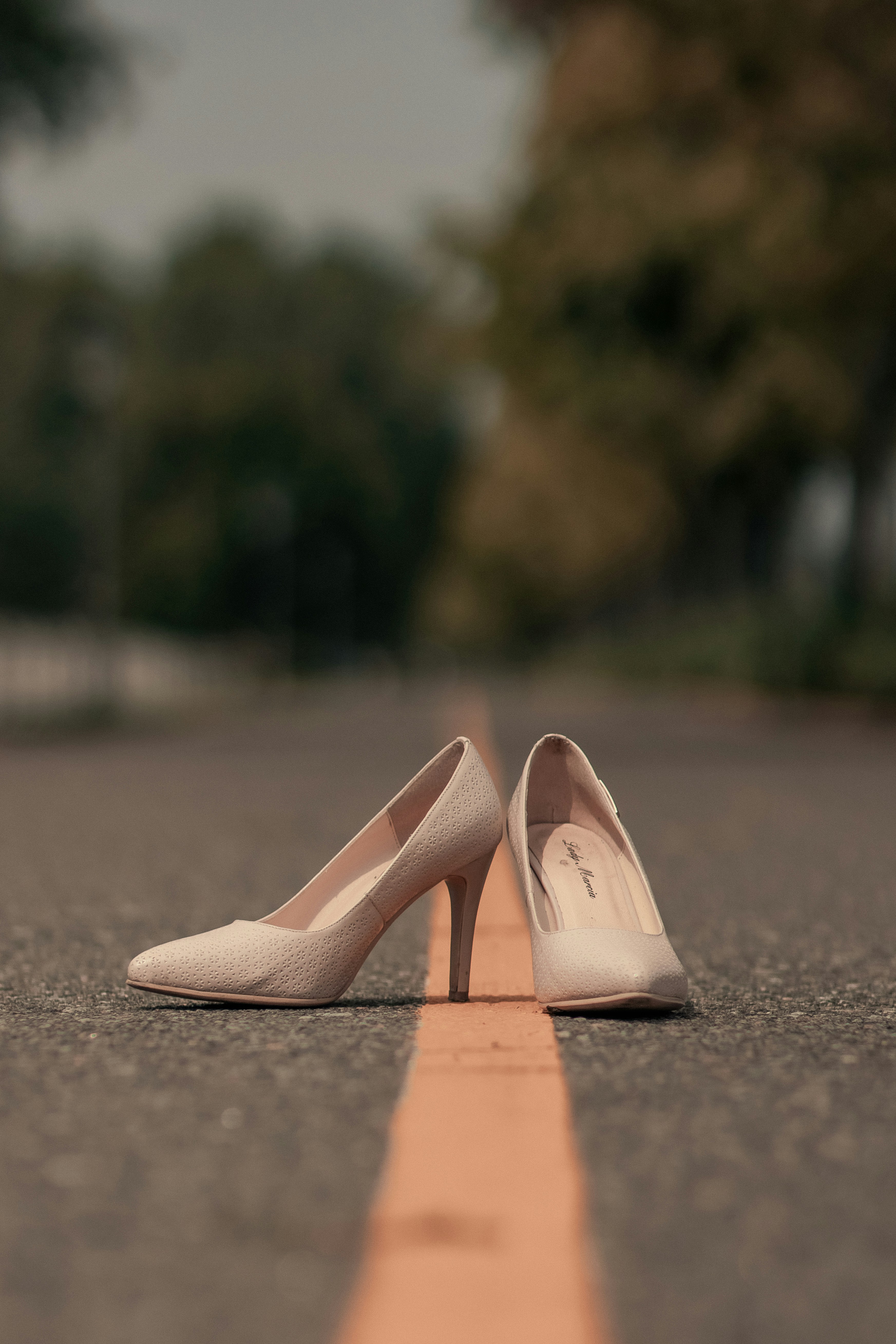 Centerline Strides: Nude Pumps on a Quiet Road