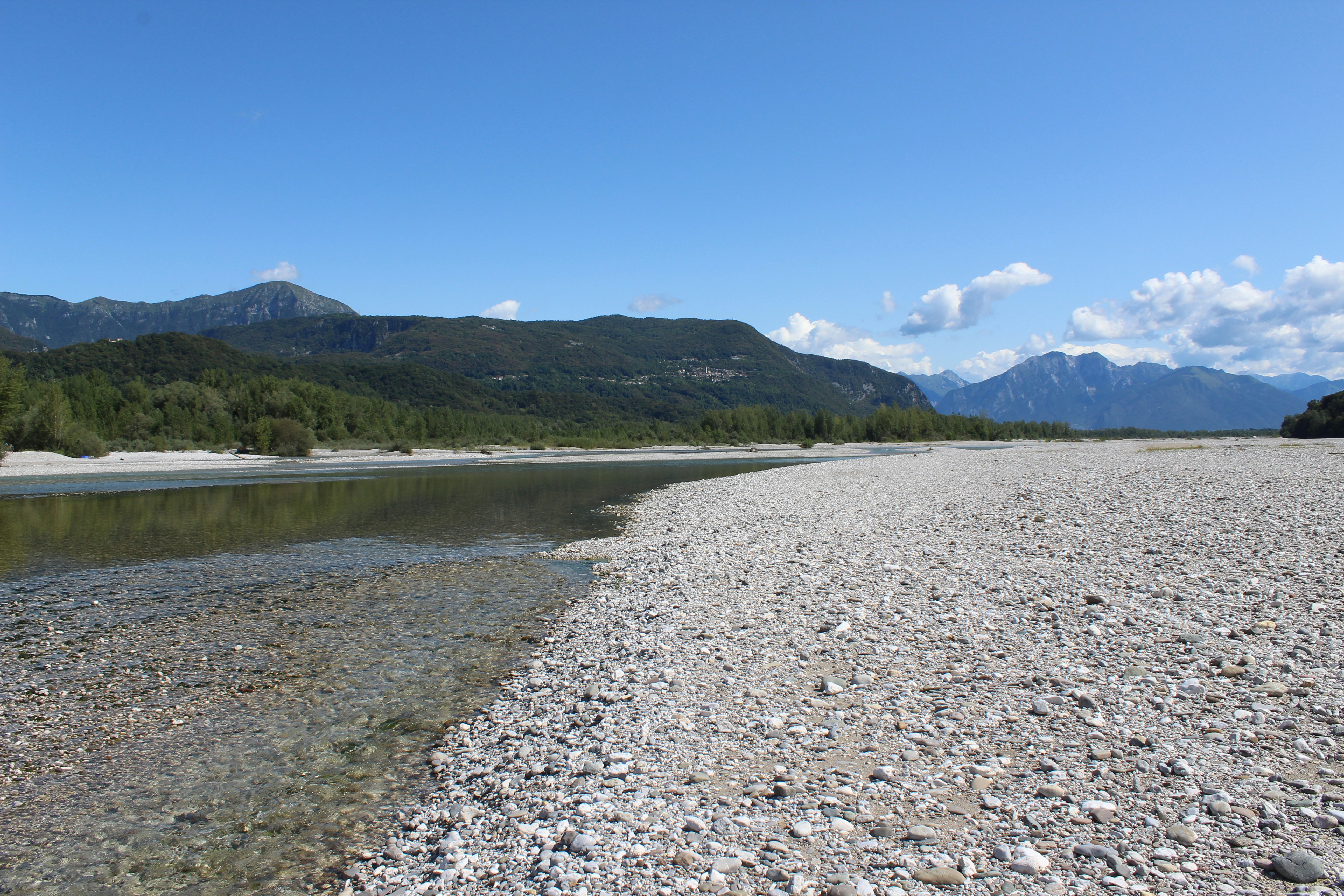 Pebble Riverbank at the Foot of Faraway Peaks