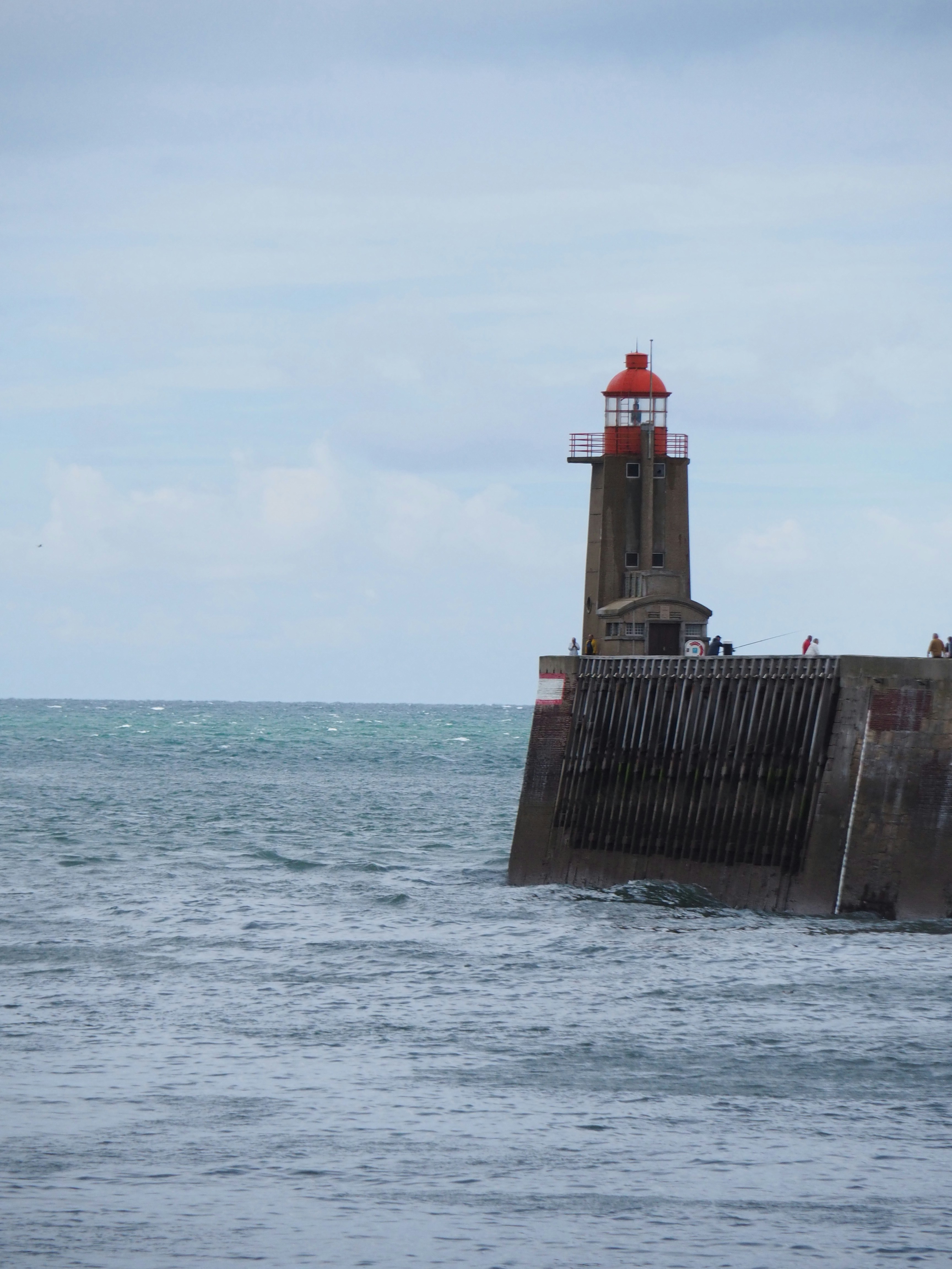 Red Lantern on the Breakwater: A Quiet Sentinel Over Choppy Seas
