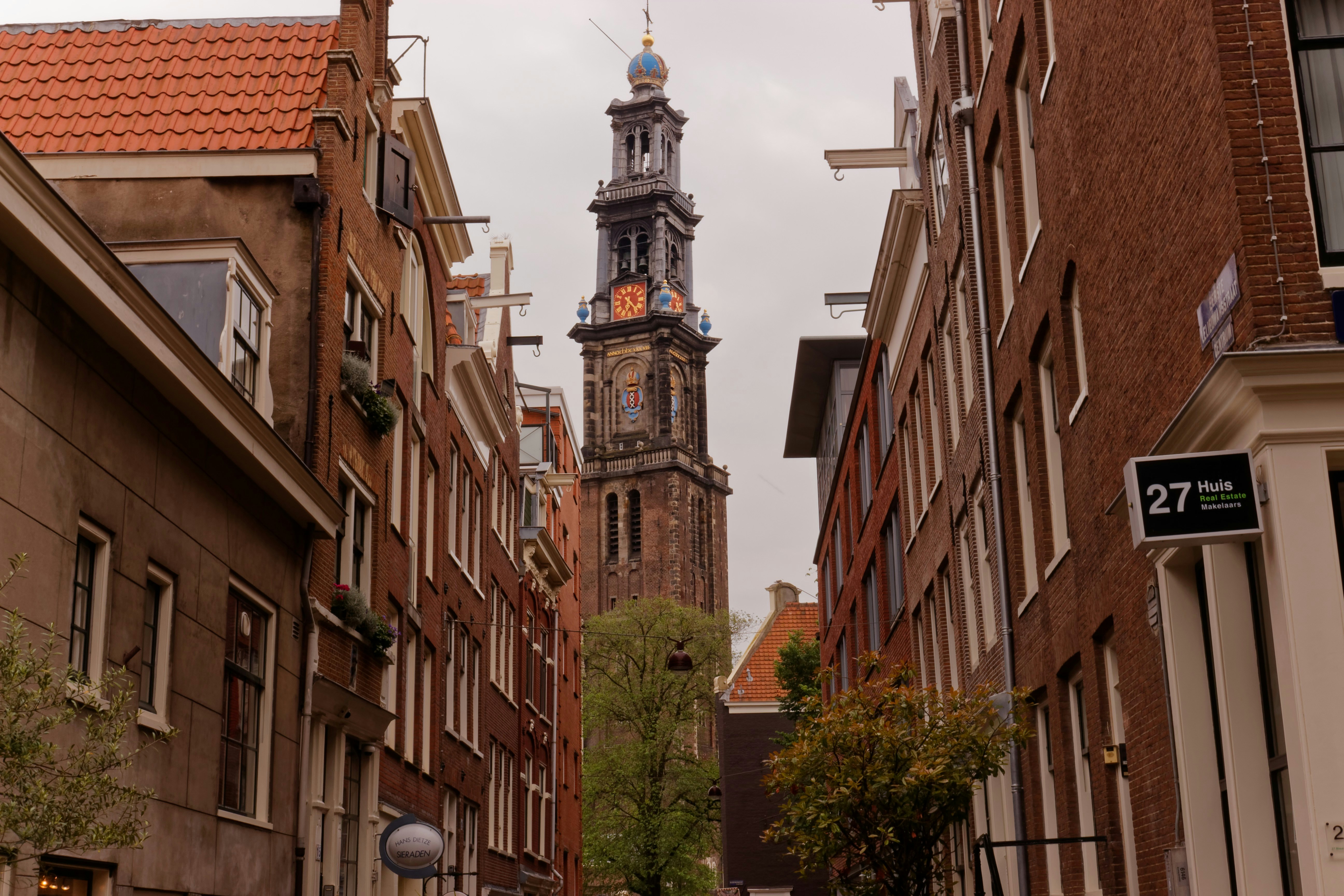 A tall clock tower towering over a city street photo – Free Photograph ...