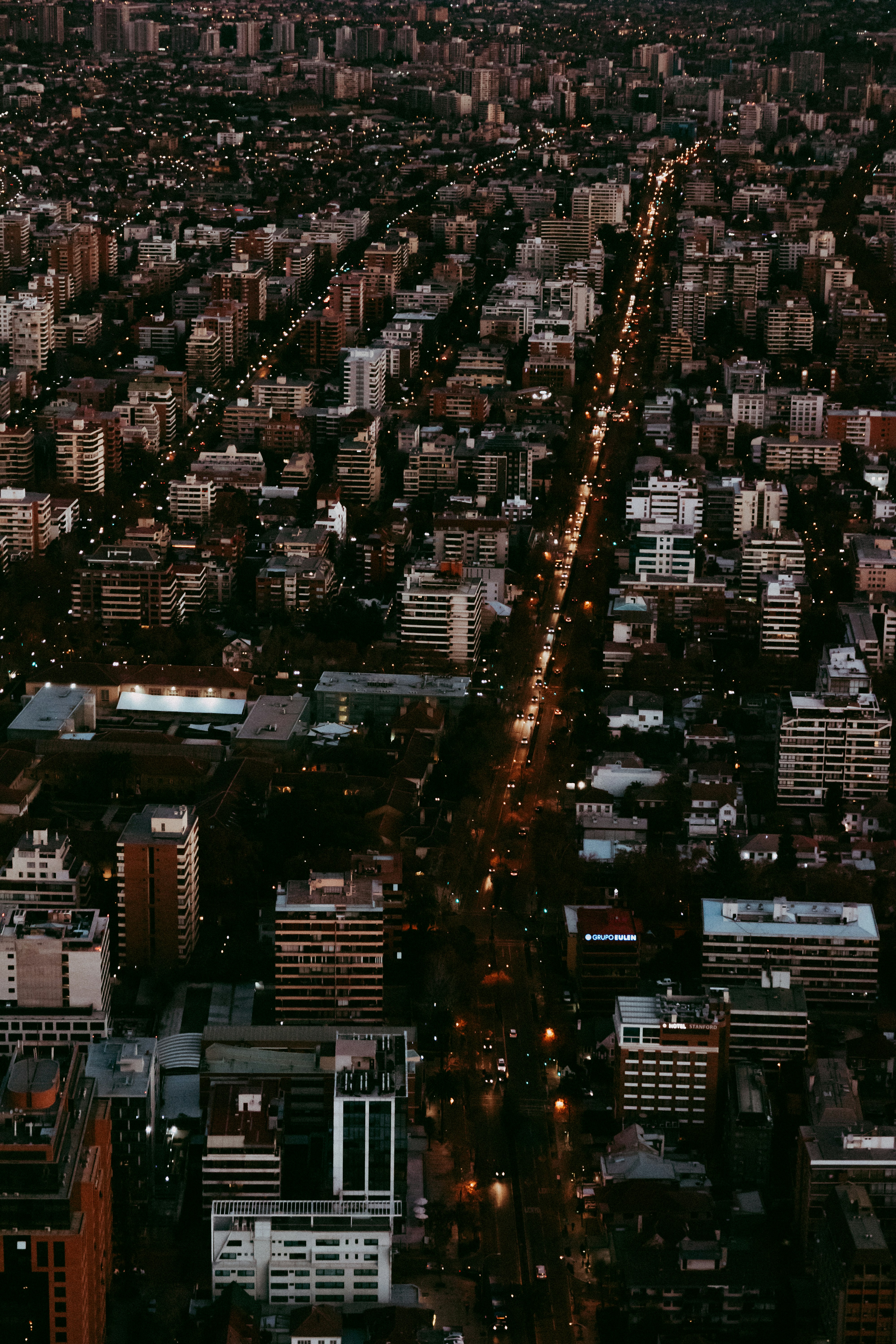 Neon Spine Over a Dense Night City Grid