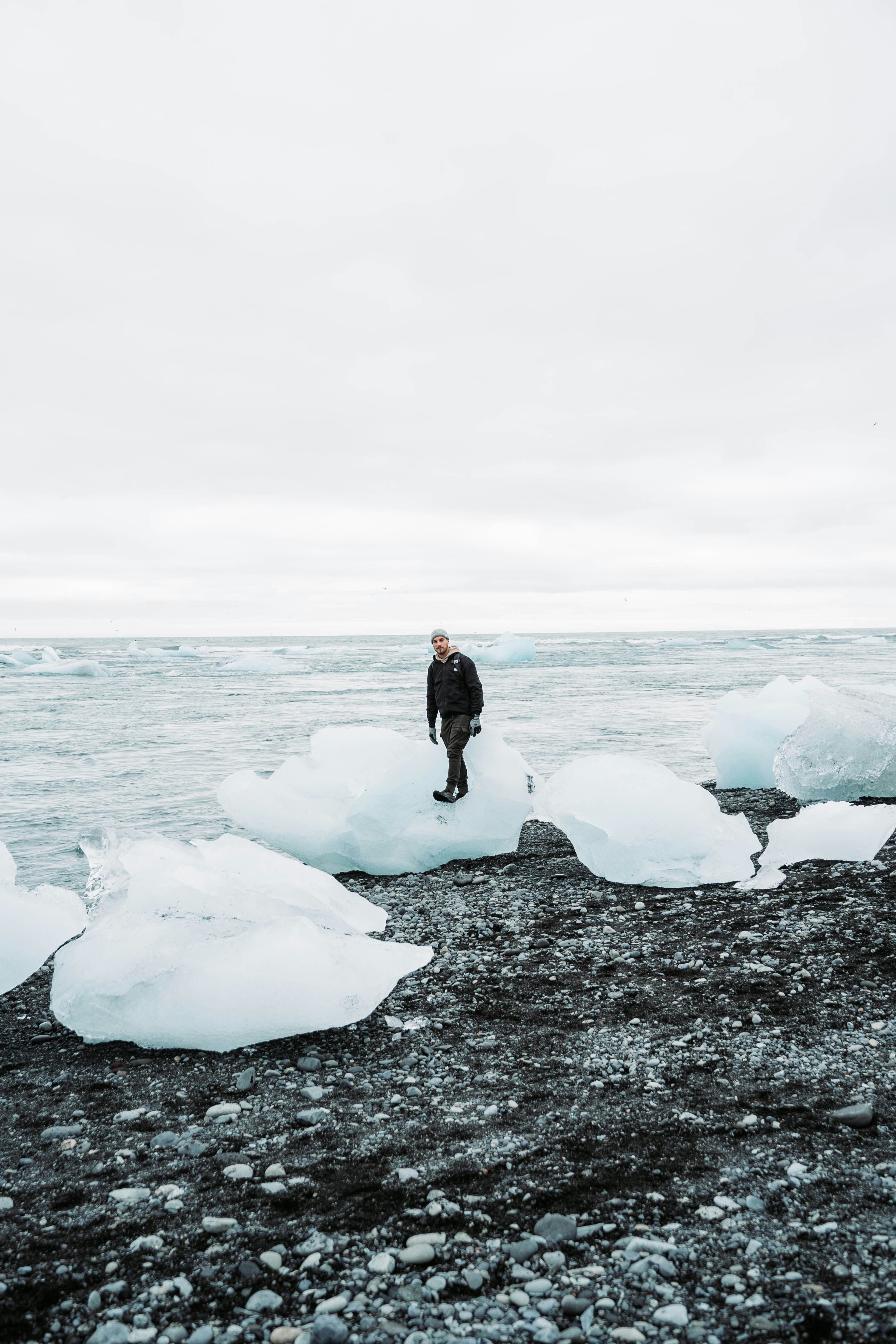 Icebound Solo: A Wanderer Stands Amid Frozen Shoreline