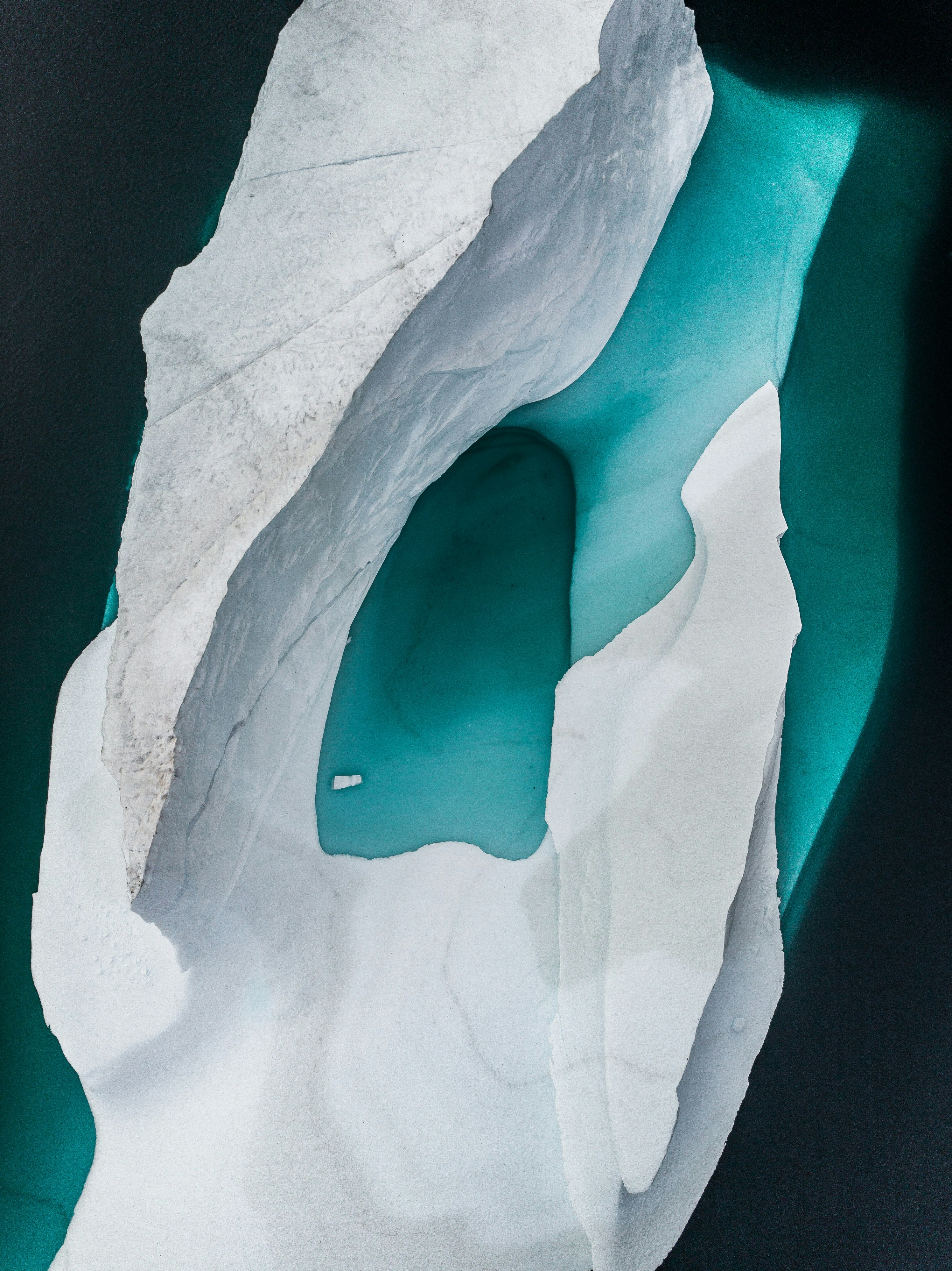 Intricate ice formations reveal a blend of white and turquoise hues, showcasing the natural artistry of glacial landscapes.