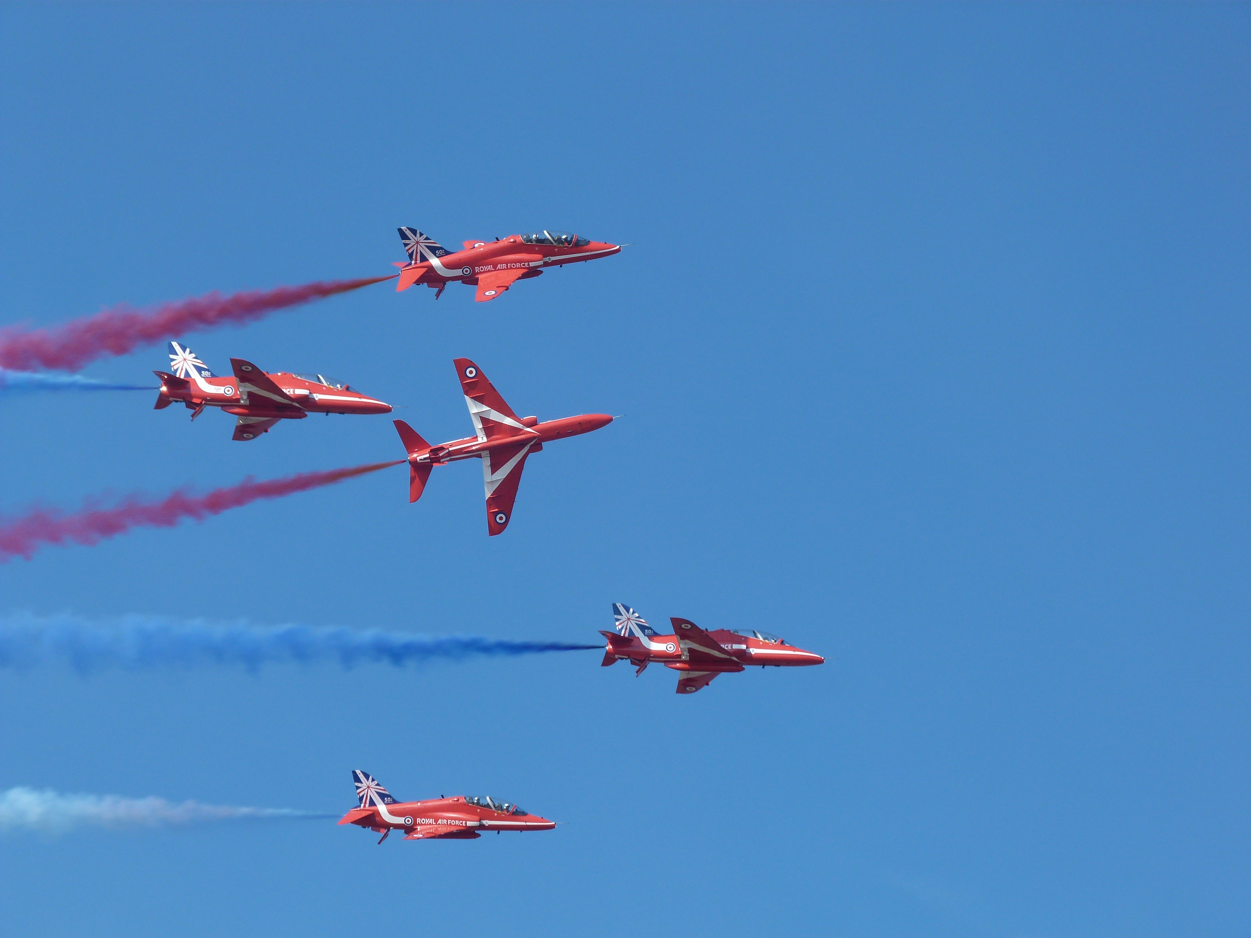 Five red planes in mid air with different color contrails photo – Free ...