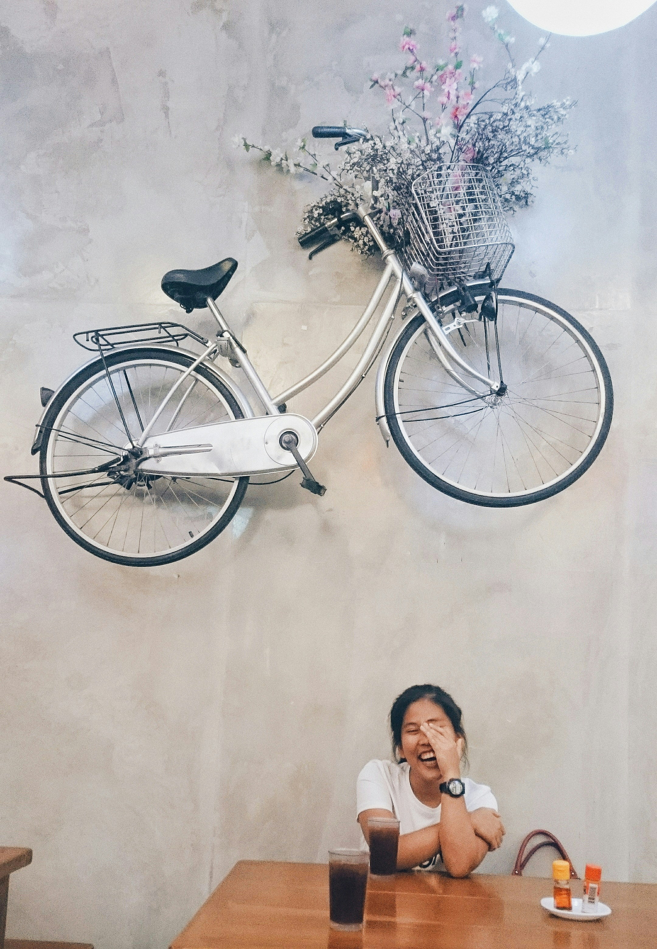 Bicycle on a Concrete Wall, with a Laughing Restaurateur