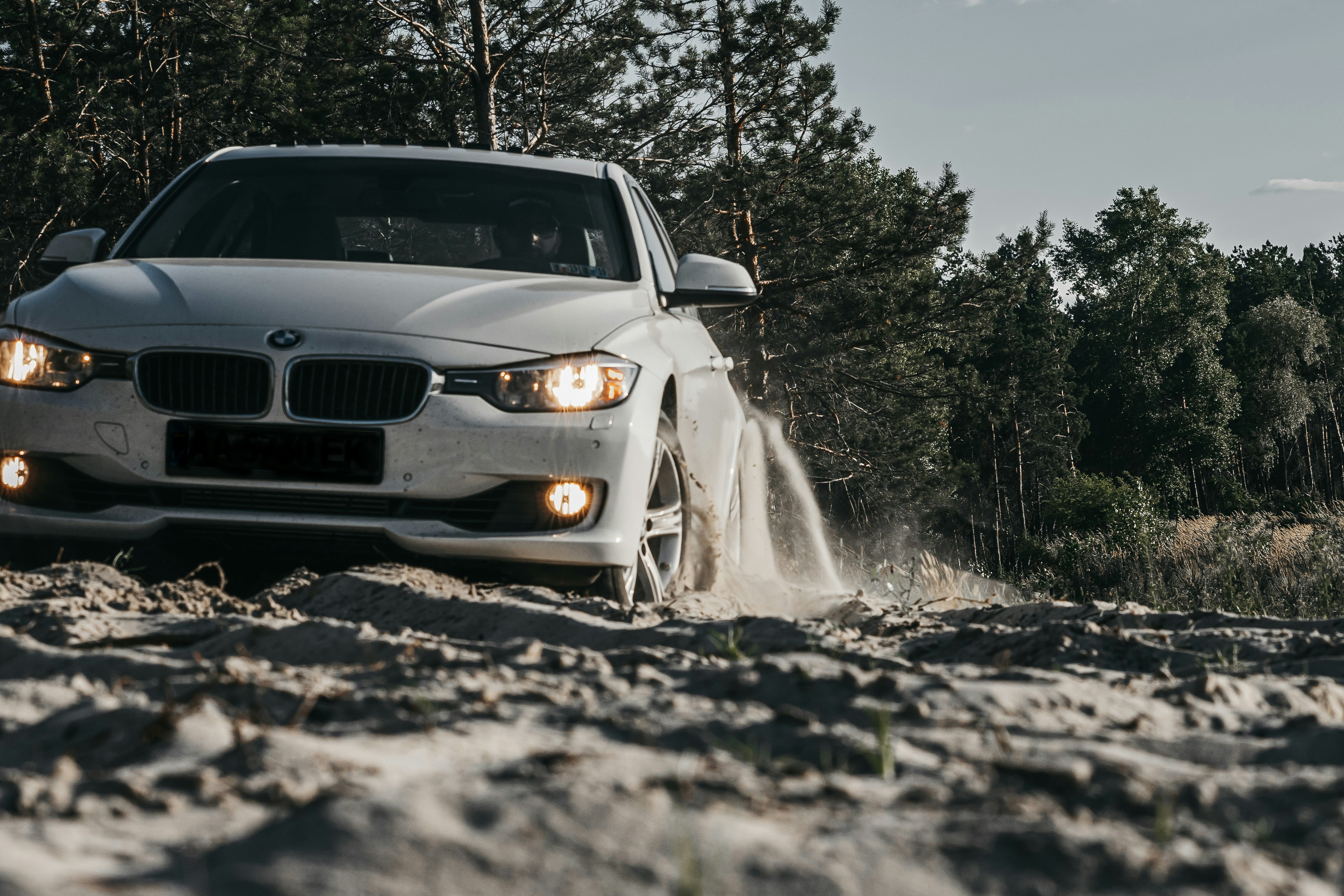 Gravel Rush: White BMW Powers Through a Dusty Off-Road