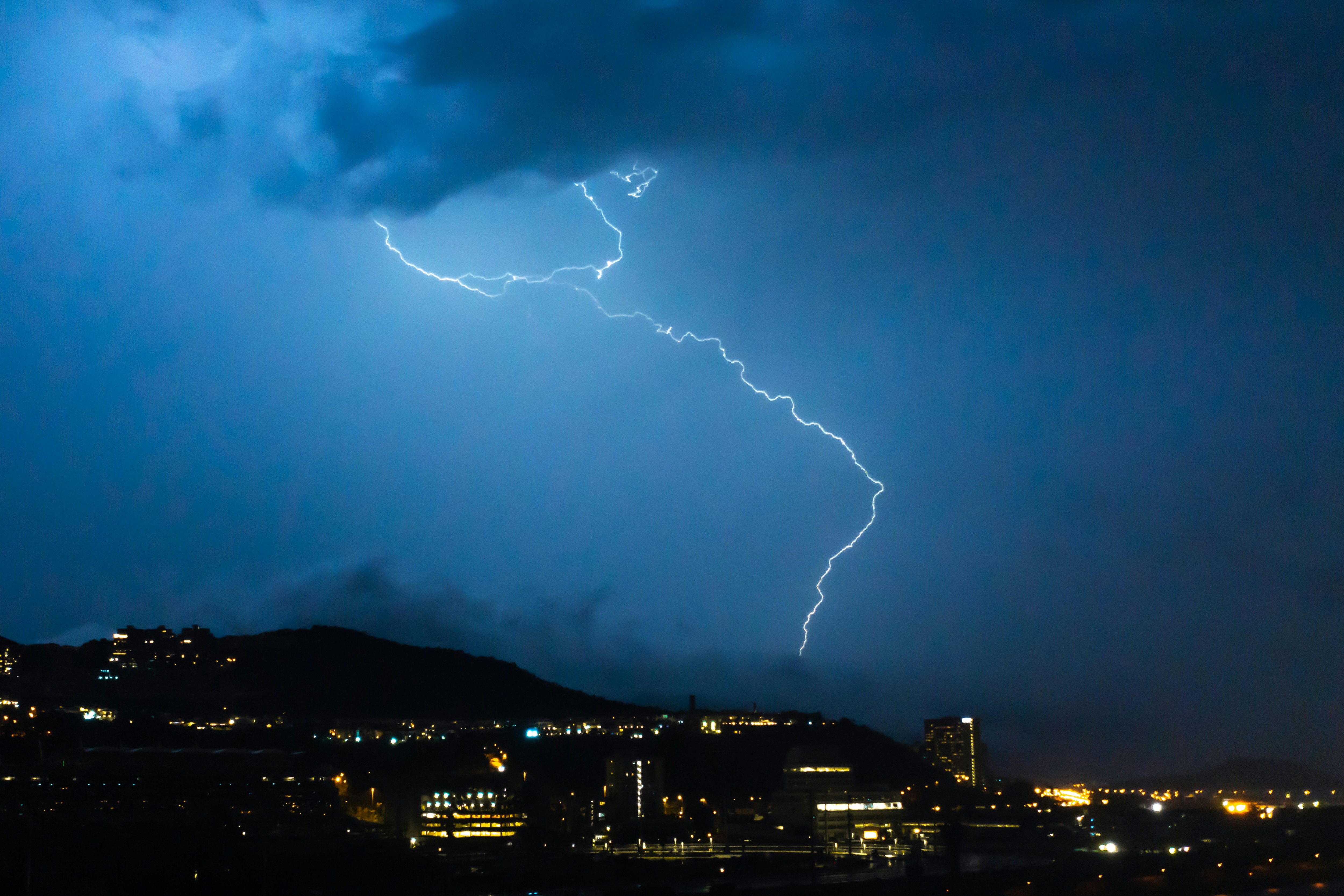 City with high-rise buildings viewing lightning during night time photo ...