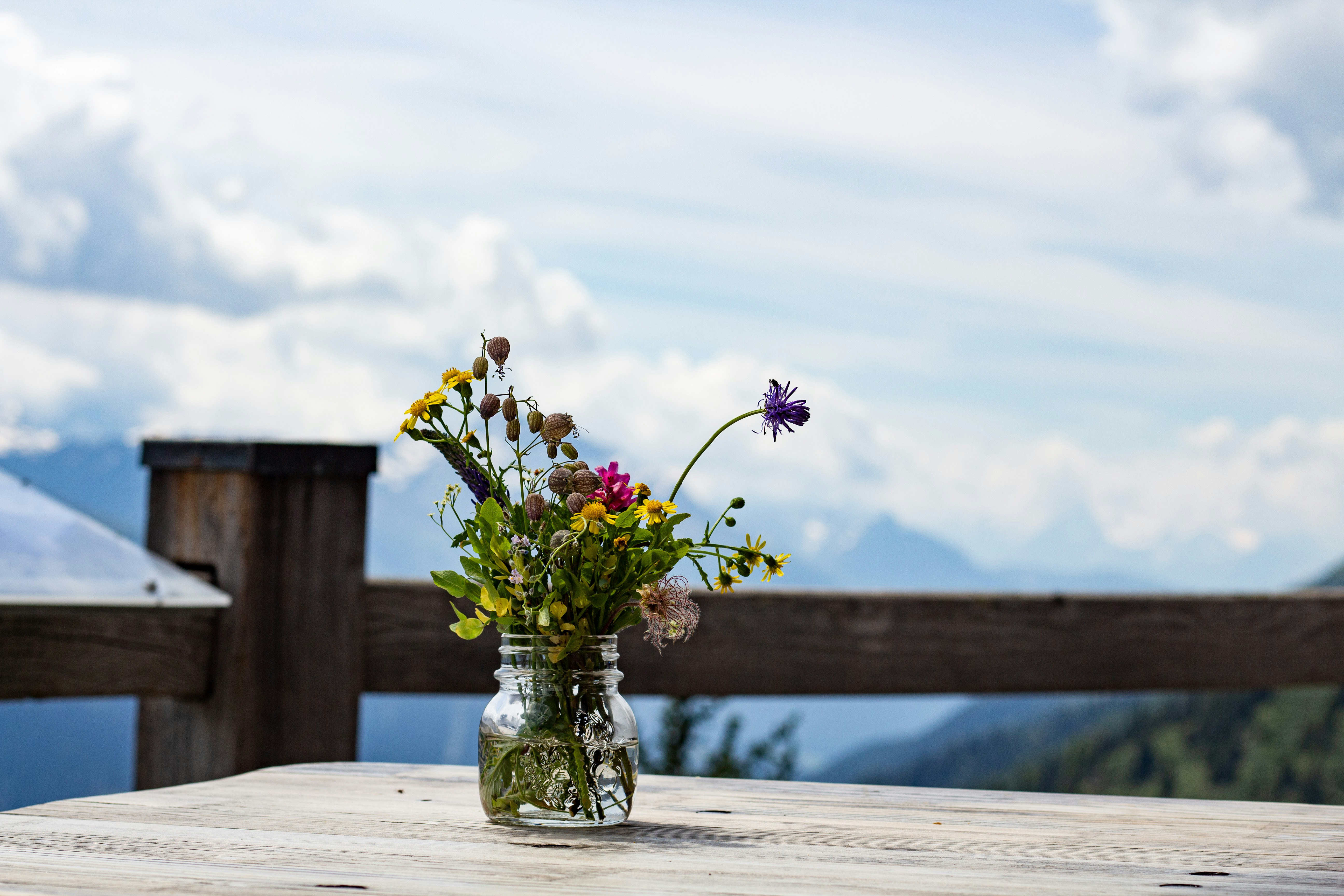 Mason Jar of Wildflowers Anchoring a Mountain-View Terrace