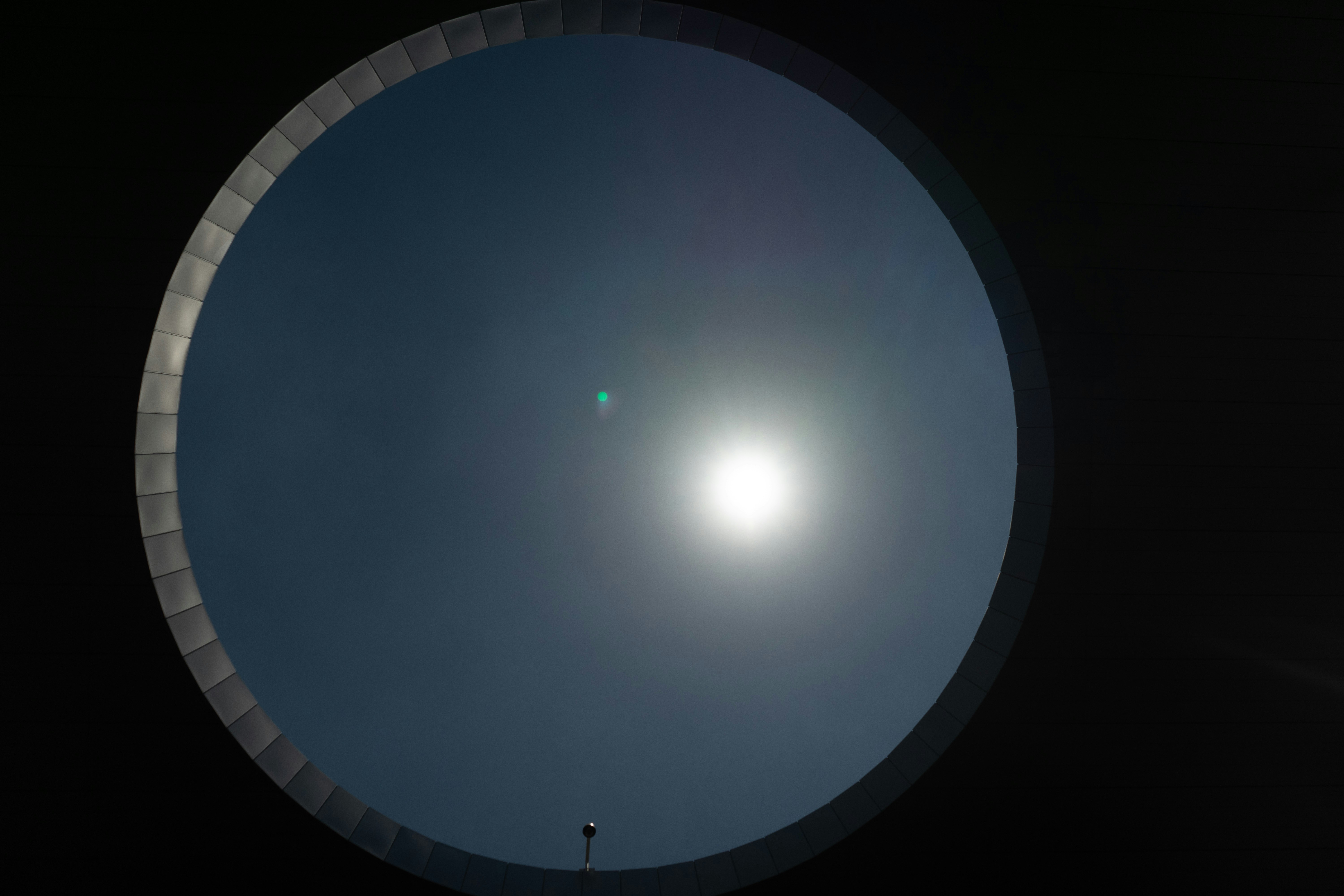 Circle of Light: Sunlit Sky Through a Circular Skylight in a Dark Room