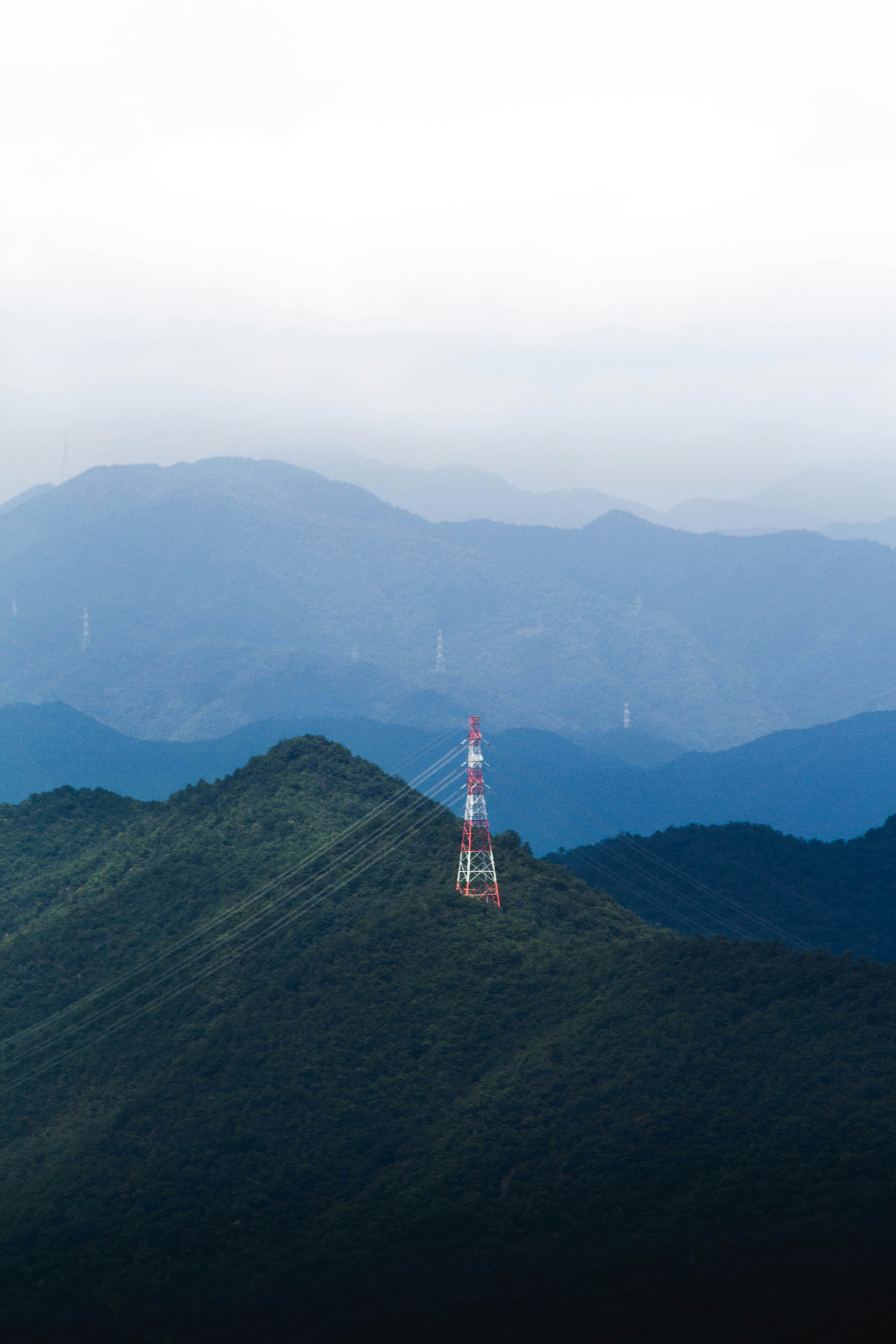 Transmission Tower Crowned Peak: Echoes Over Misty Ridges