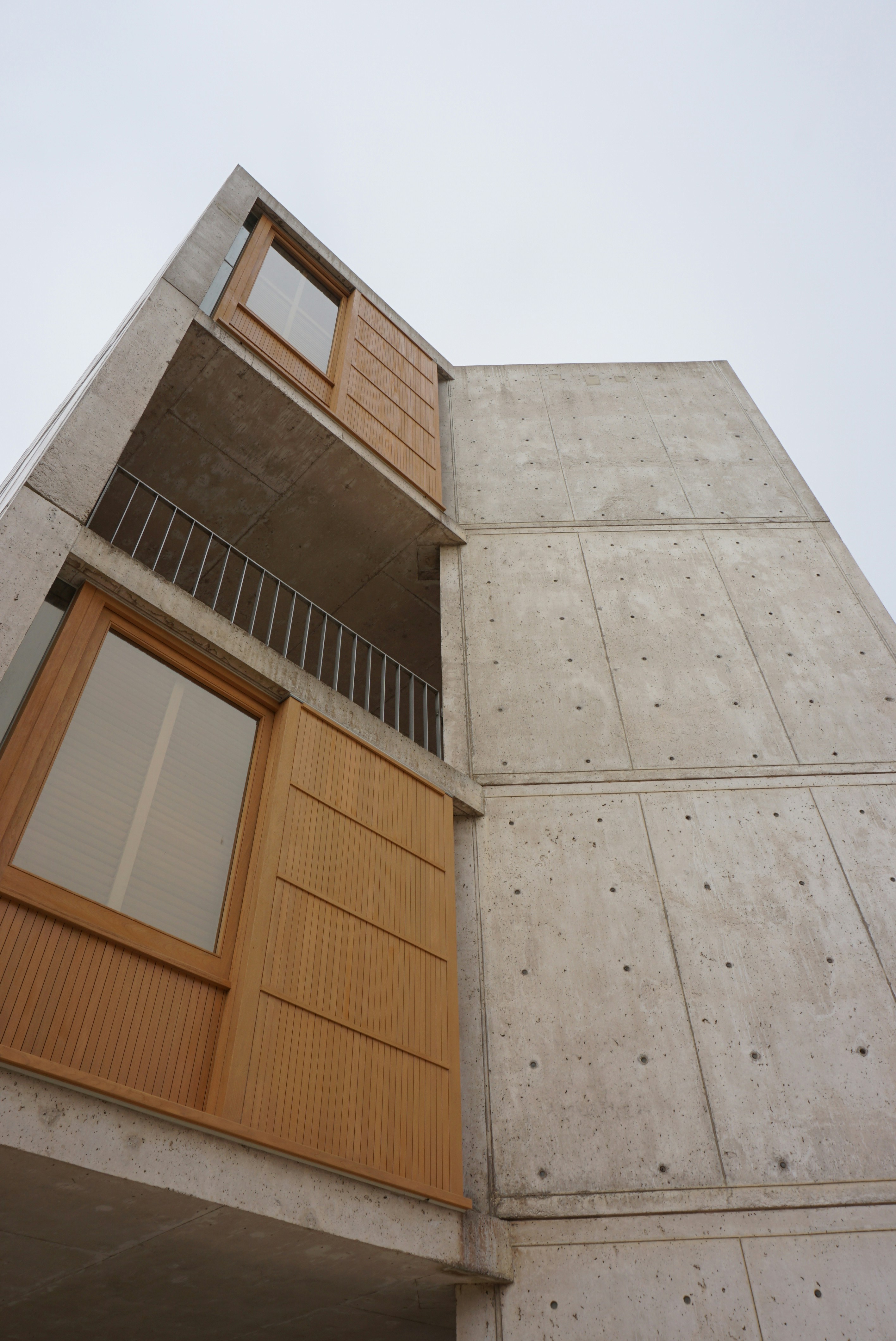 Corner of Brutalist Wood: A Low-Angle Study of Concrete and Timber