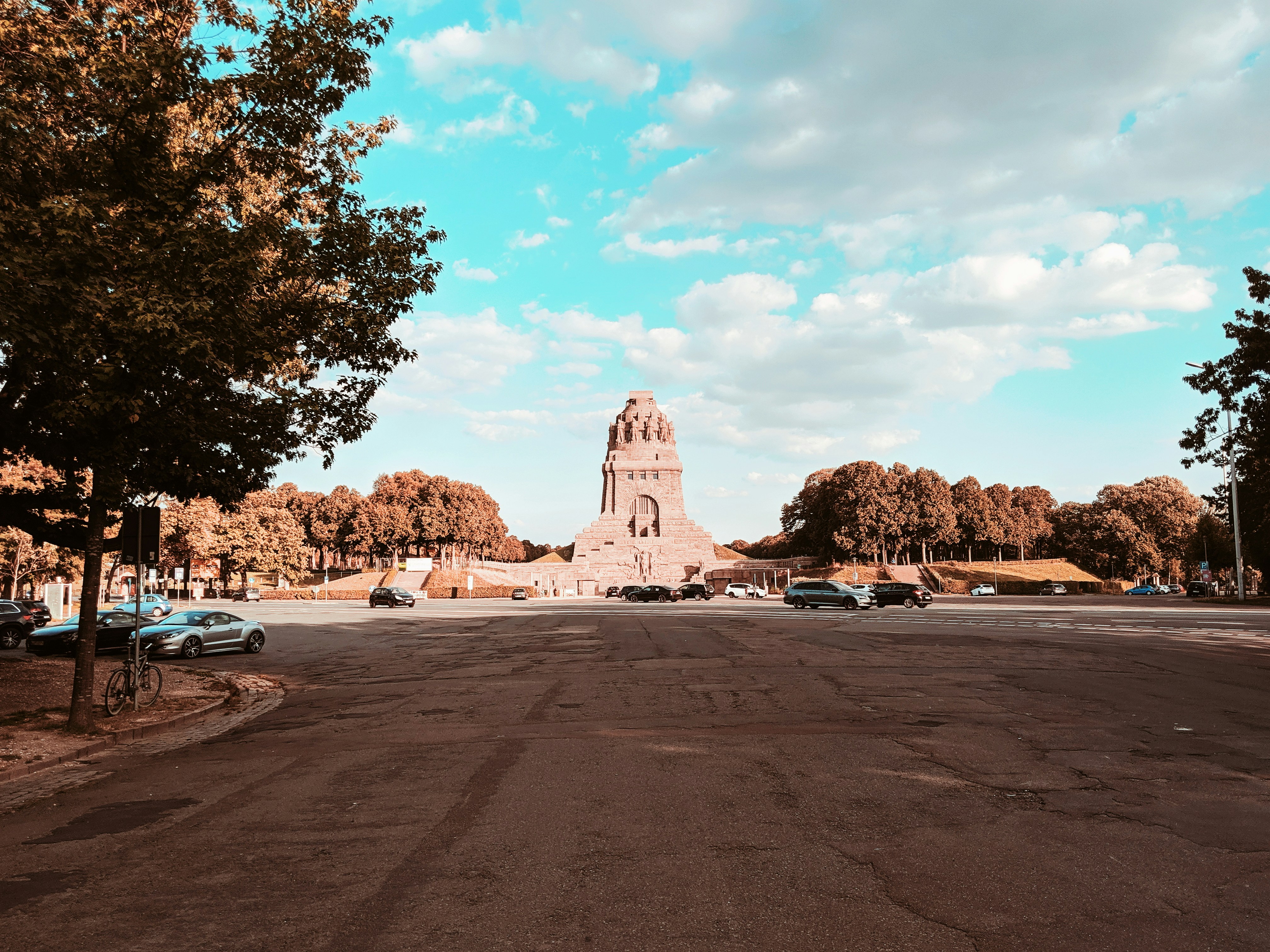 Central monument rising above a sunlit avenue