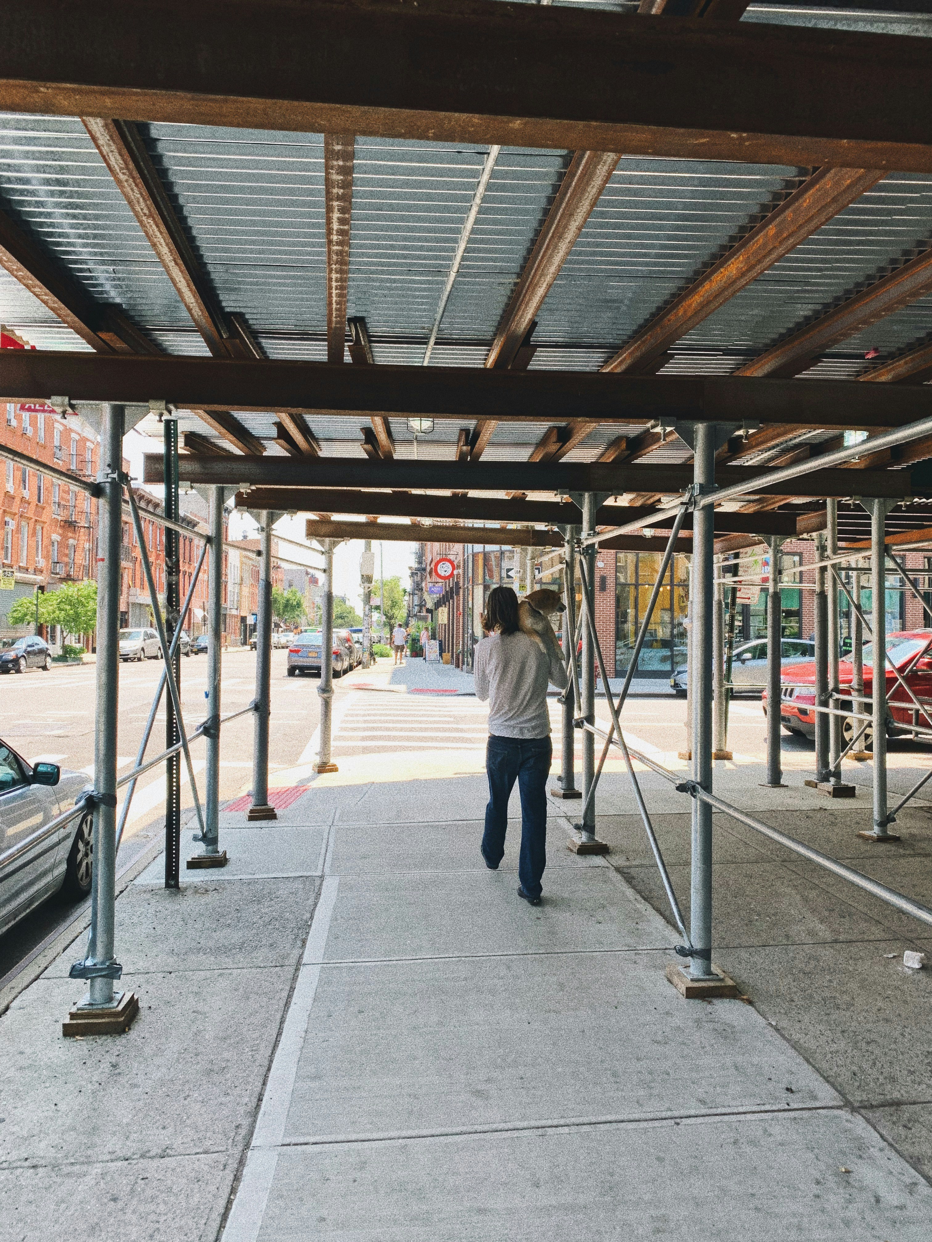 Under the City Frame: A Moment Along a Scaffolded Sidewalk