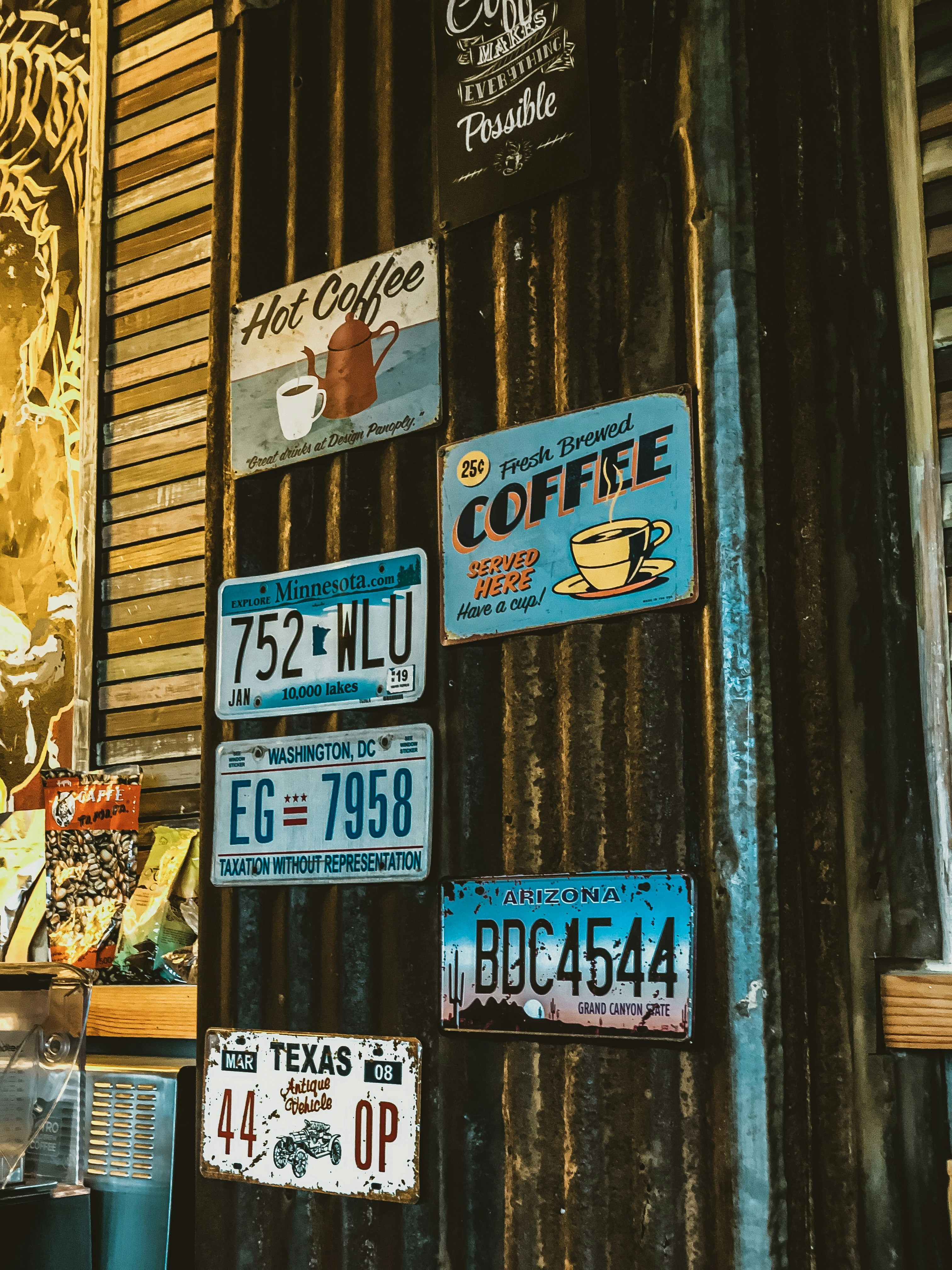 Retro Cafe Corner: license plates and weathered signage on a corrugated wall