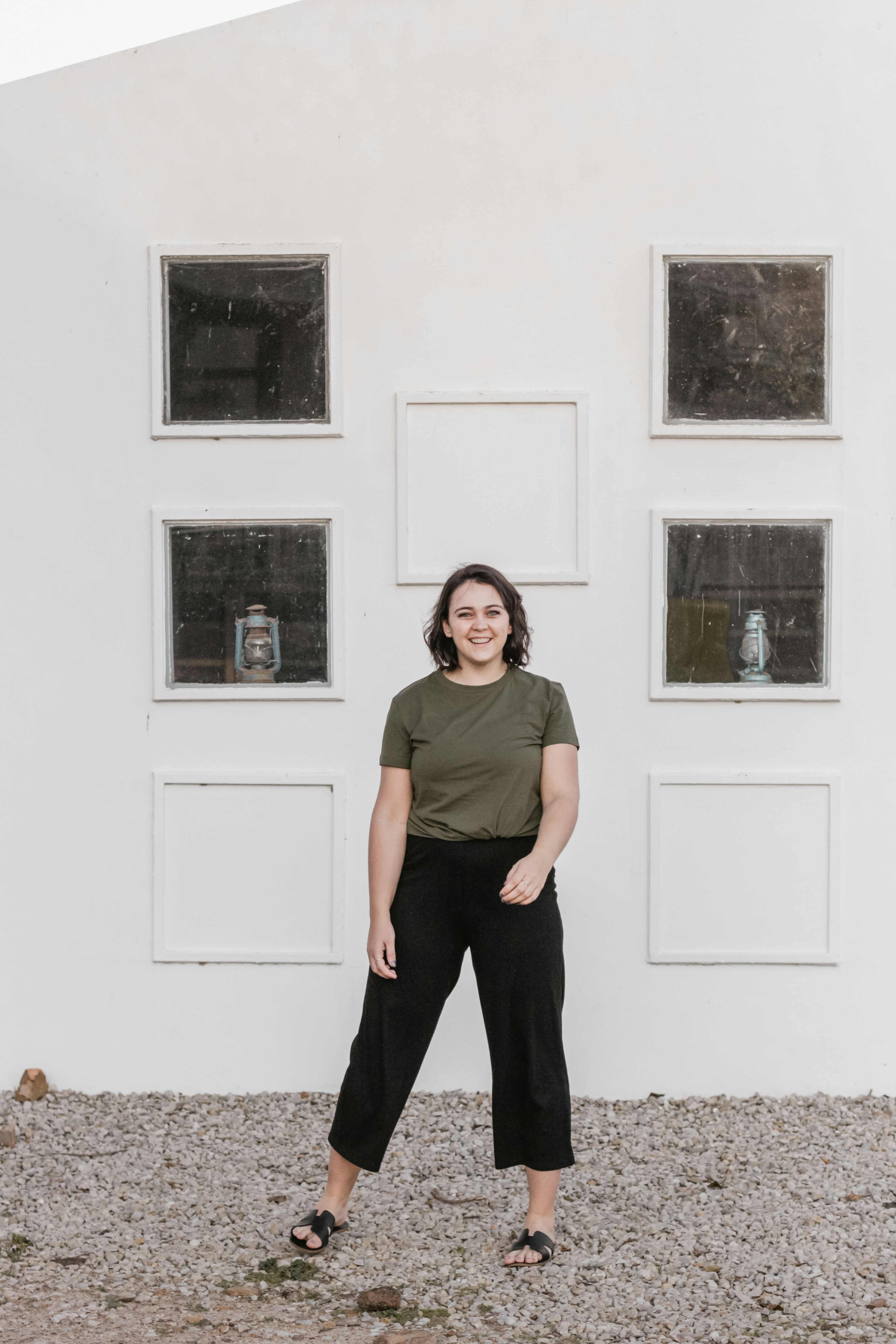 Grid-Frame Portrait: Centered Figure Before a White Facade
