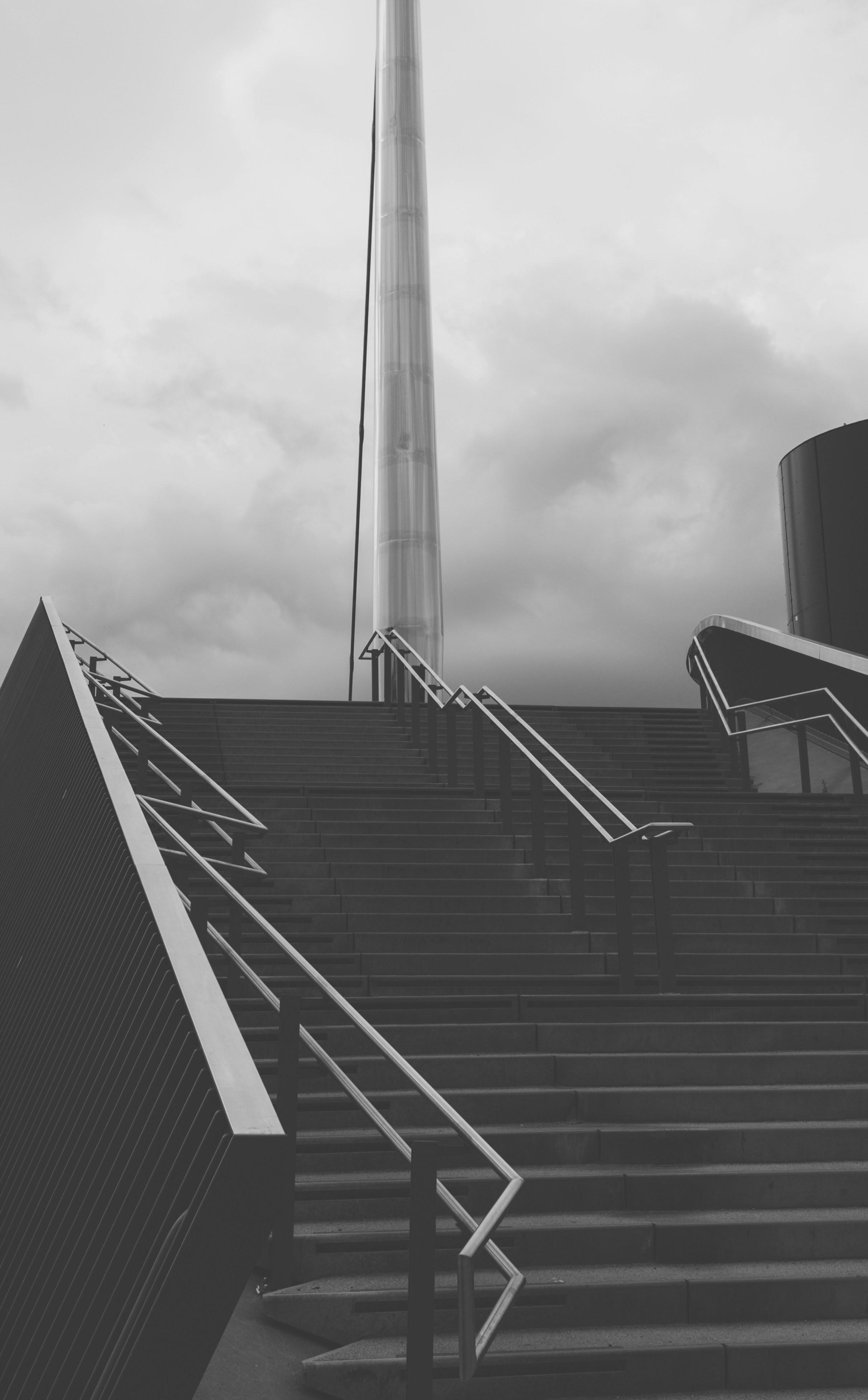 Geometric Ascent: Staircase Toward a Central Spire in Gray Light