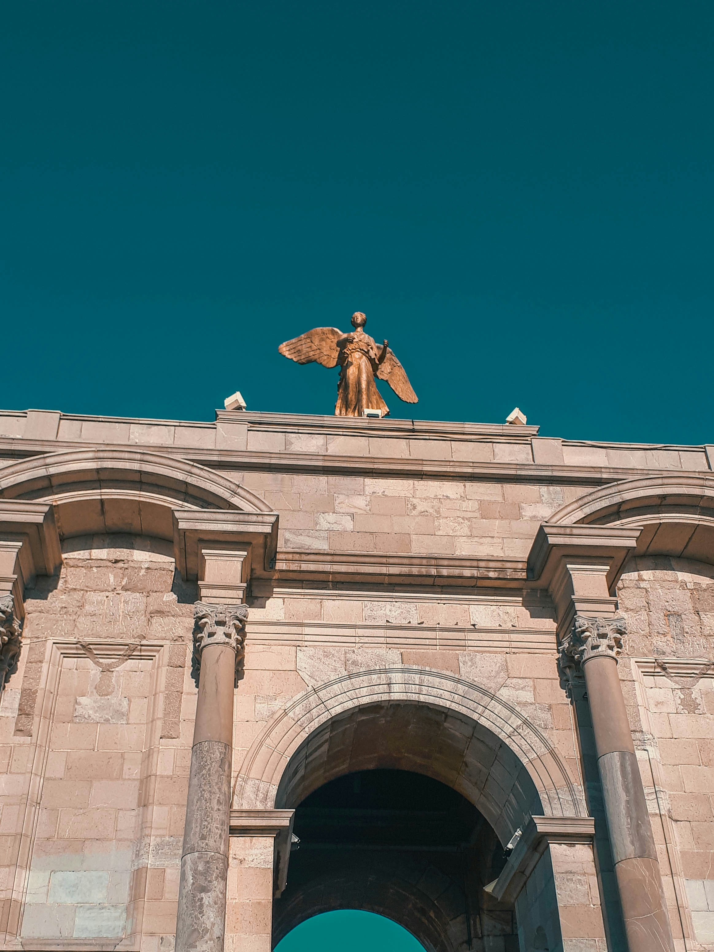 Winged Guardian Over Stone Archway