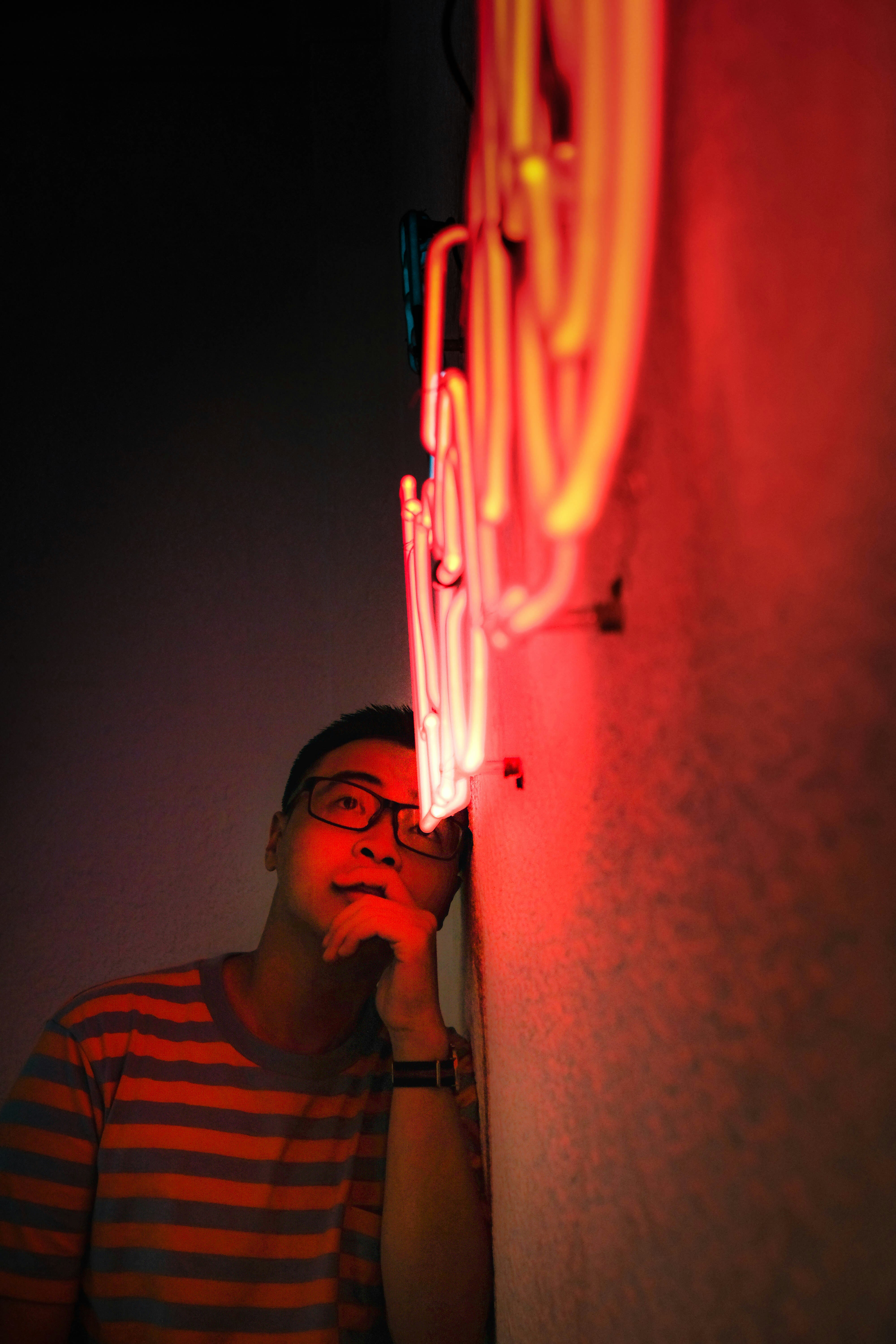 Neon Glare: A Quiet Moment by the Neon Wall