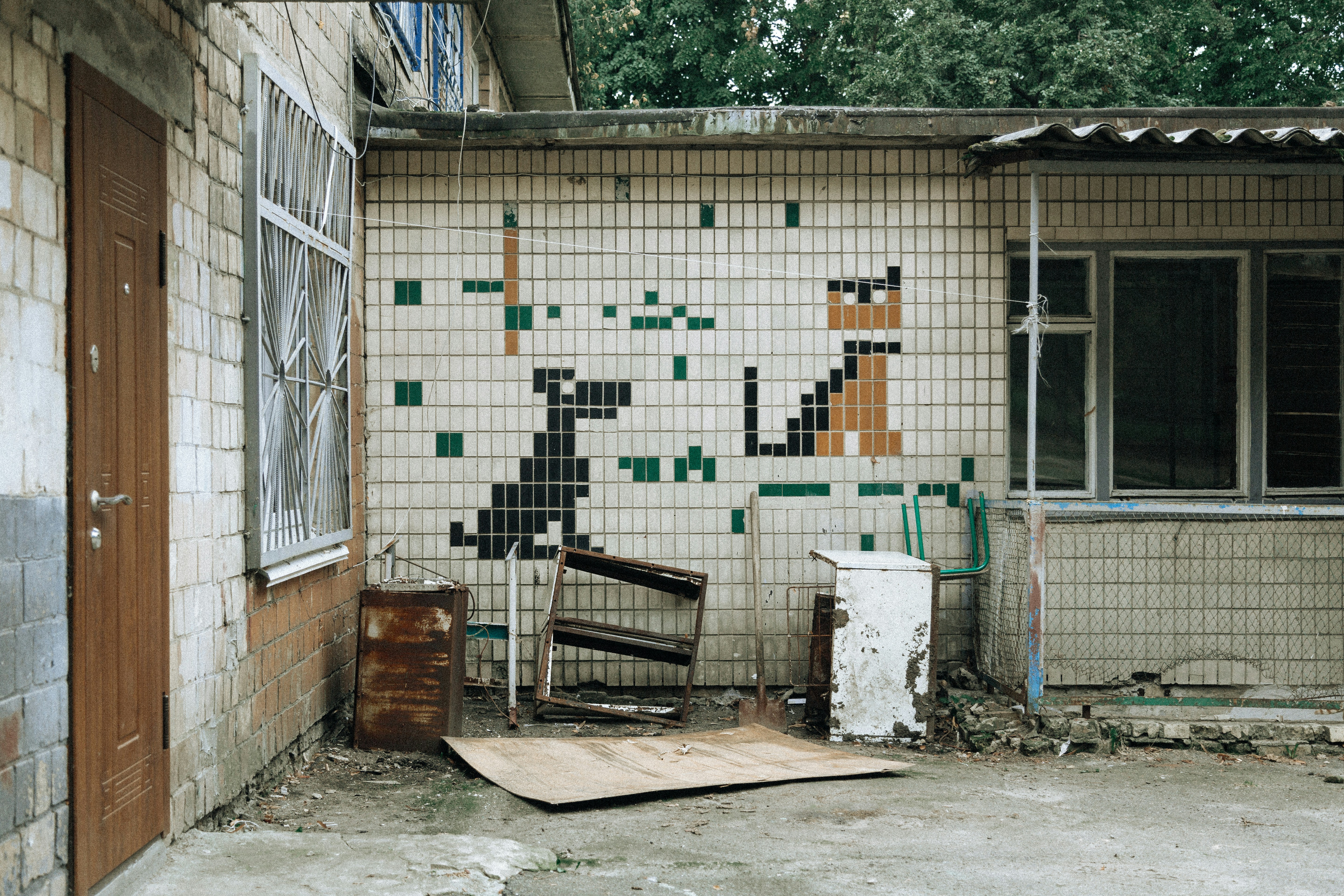 Pixel Portraits on a Weathered Playground Wall