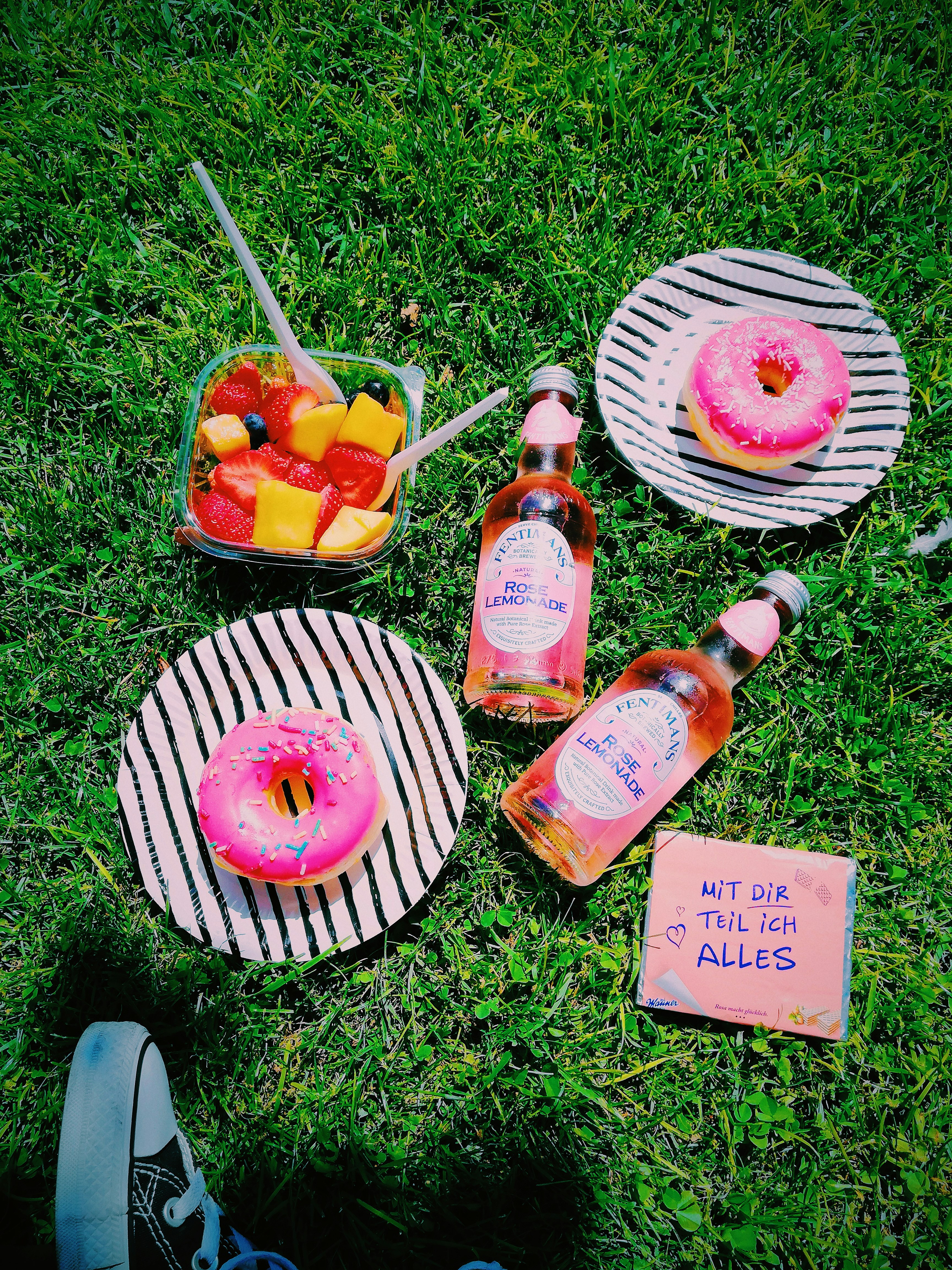 Sun-Kissed Picnic: Pink Donuts, Lemonade, and Striped Plate Delights