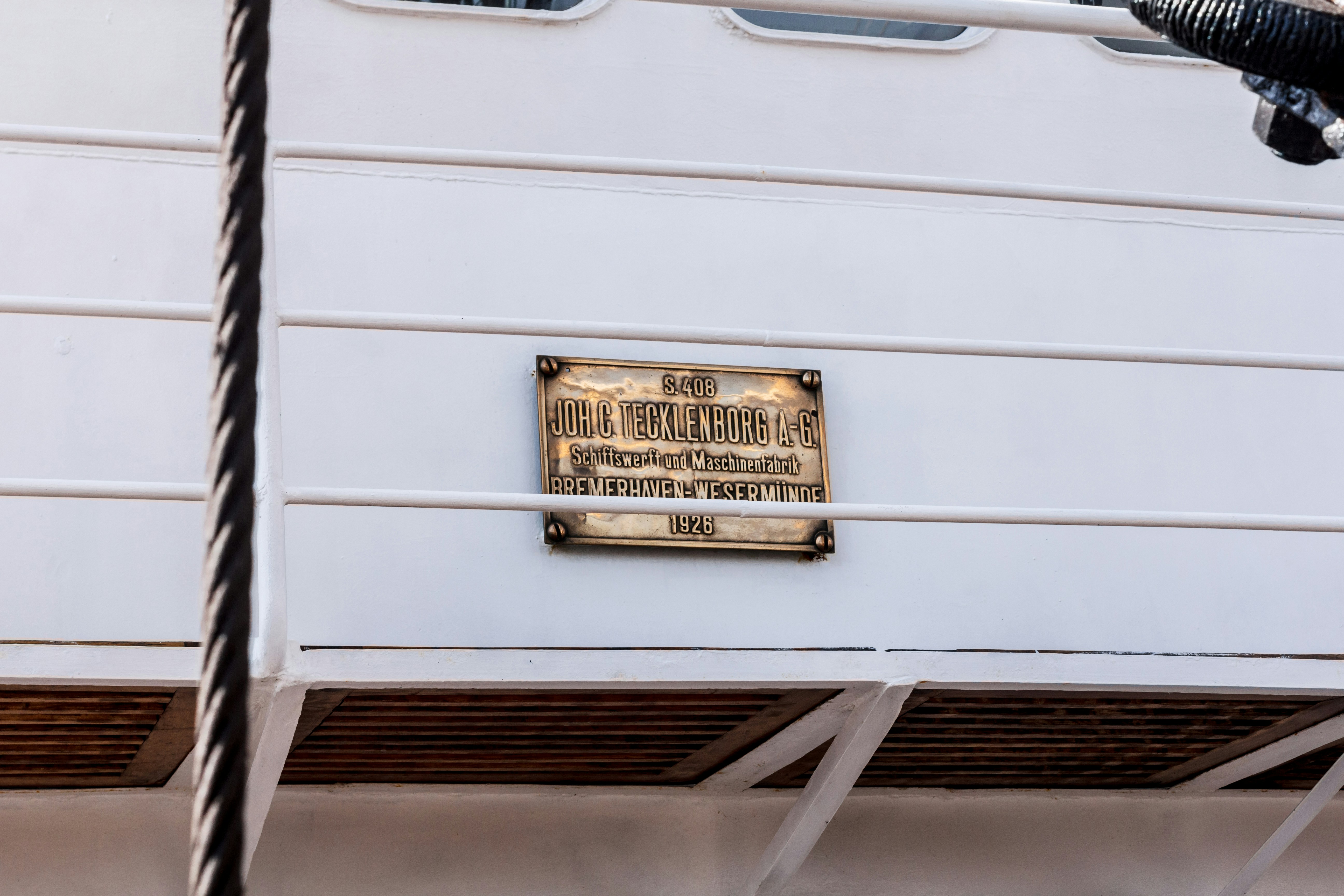 Plaque on a White Ship Exterior Signaling Maritime Heritage