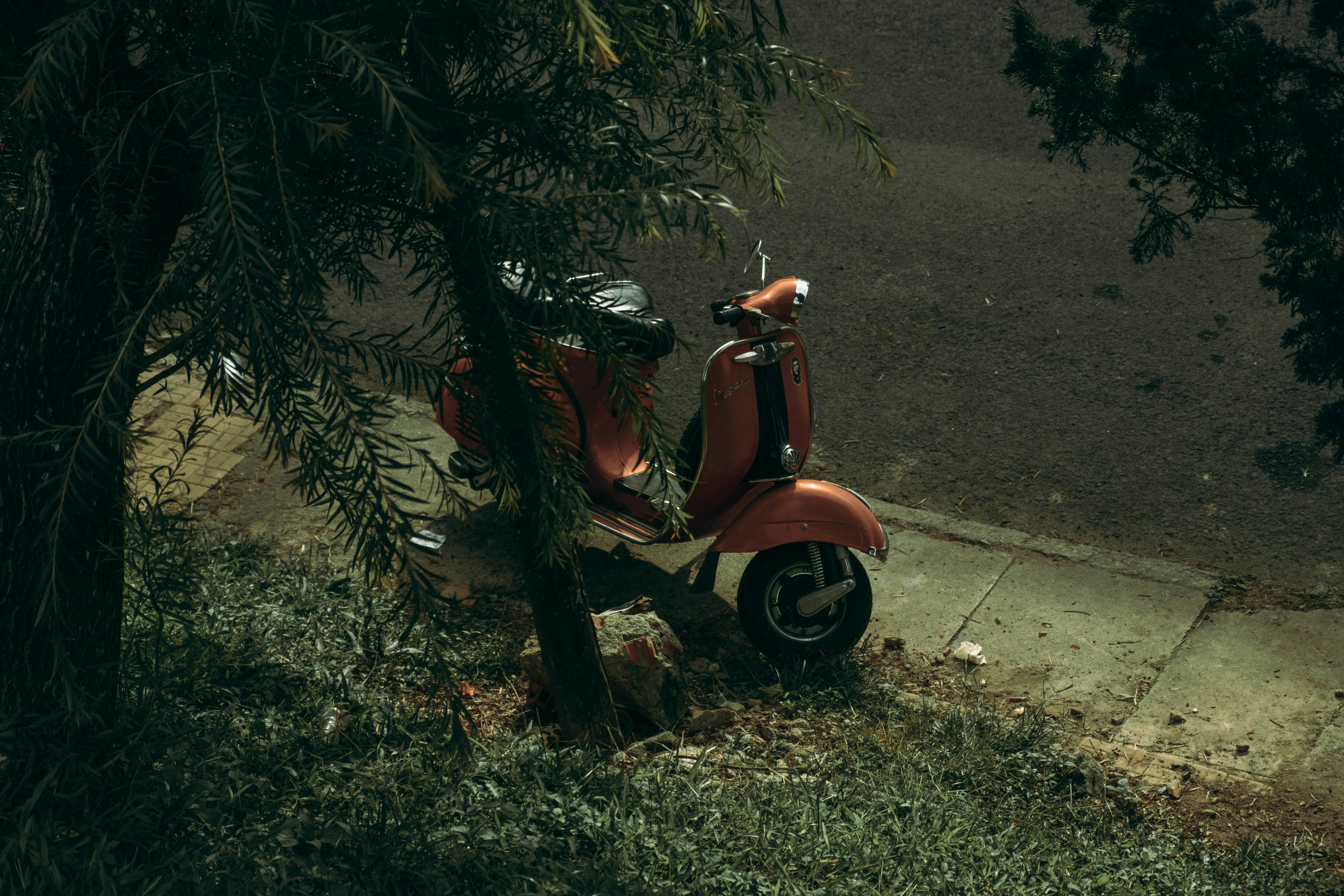 photo of orange automatic scooter on parked