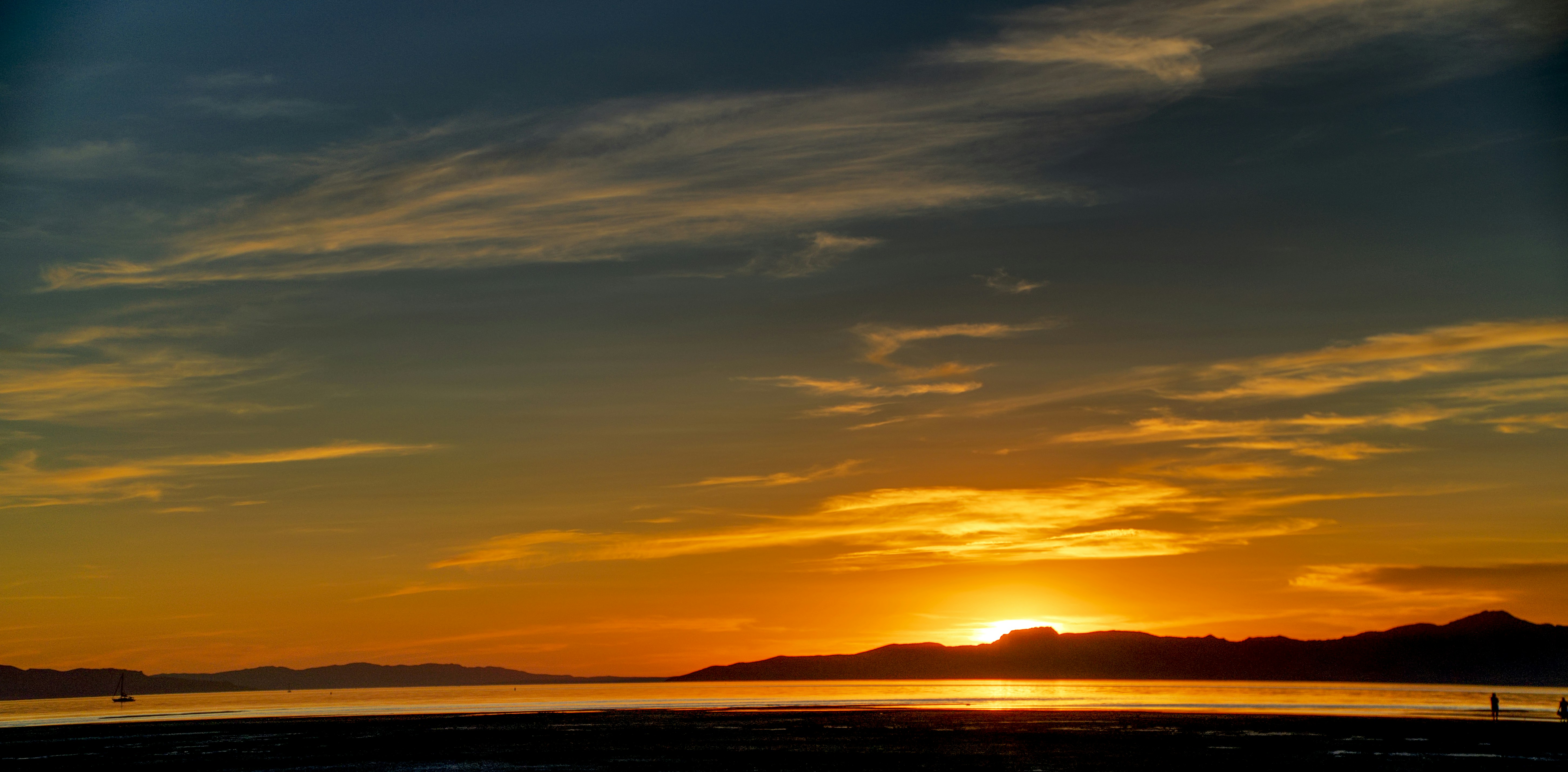 the sun is setting over a body of water