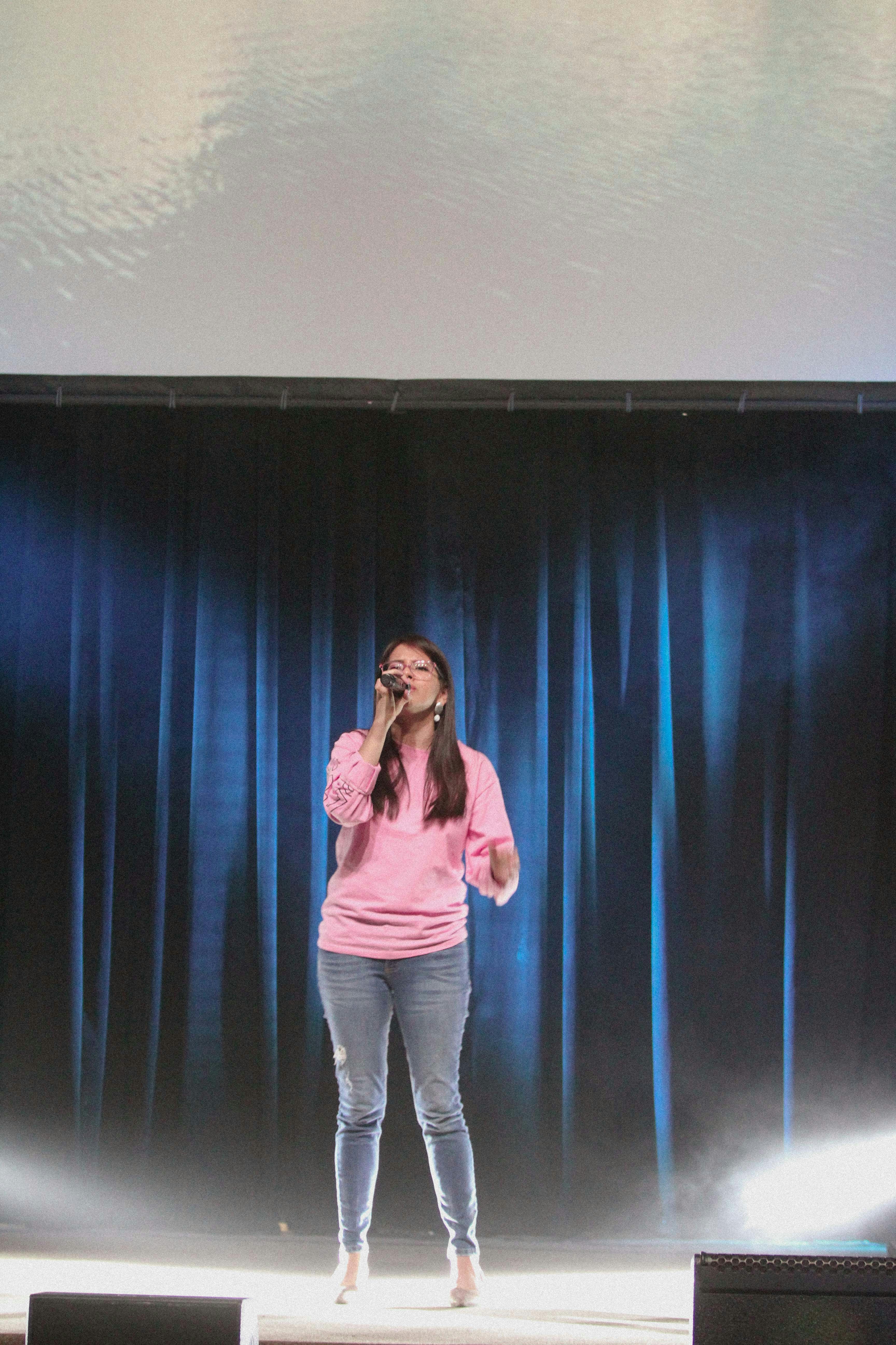 Stage Presence in a Pink Hoodie: Solo Vocal Performance