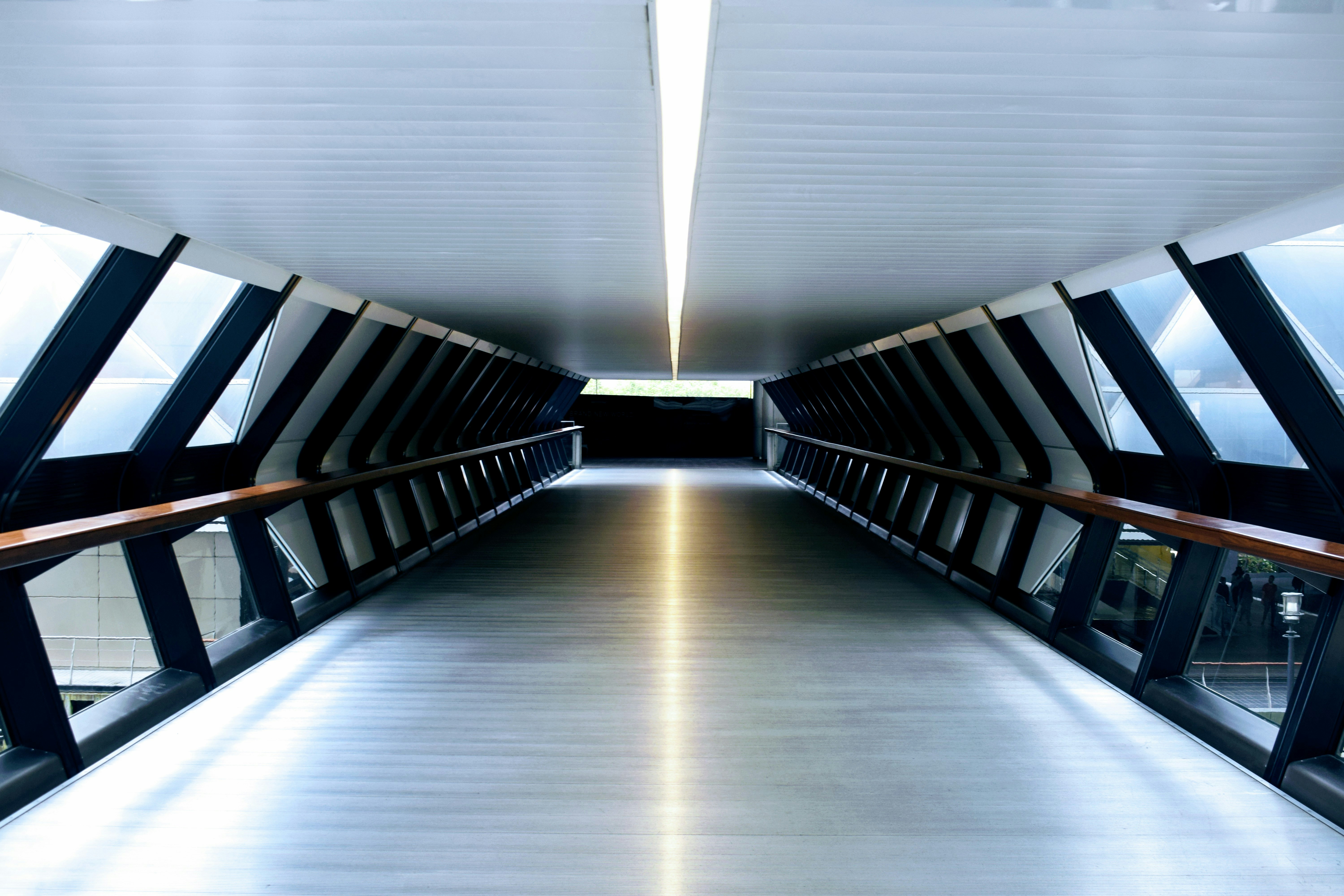 Futuristic corridor with geometric lines and contrasting light.