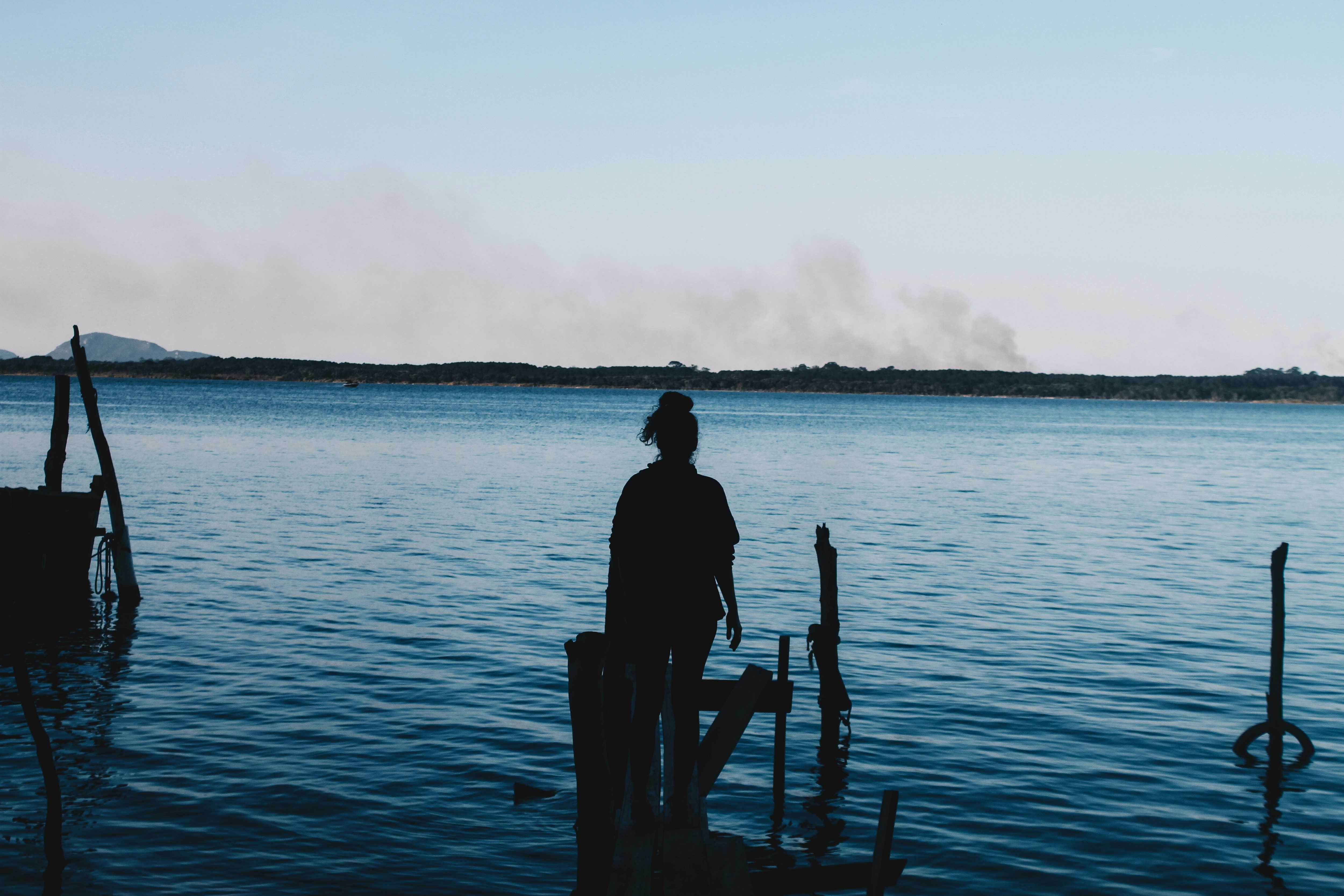 Silhouette at the Quiet Dock: A Horizon to the Unknown