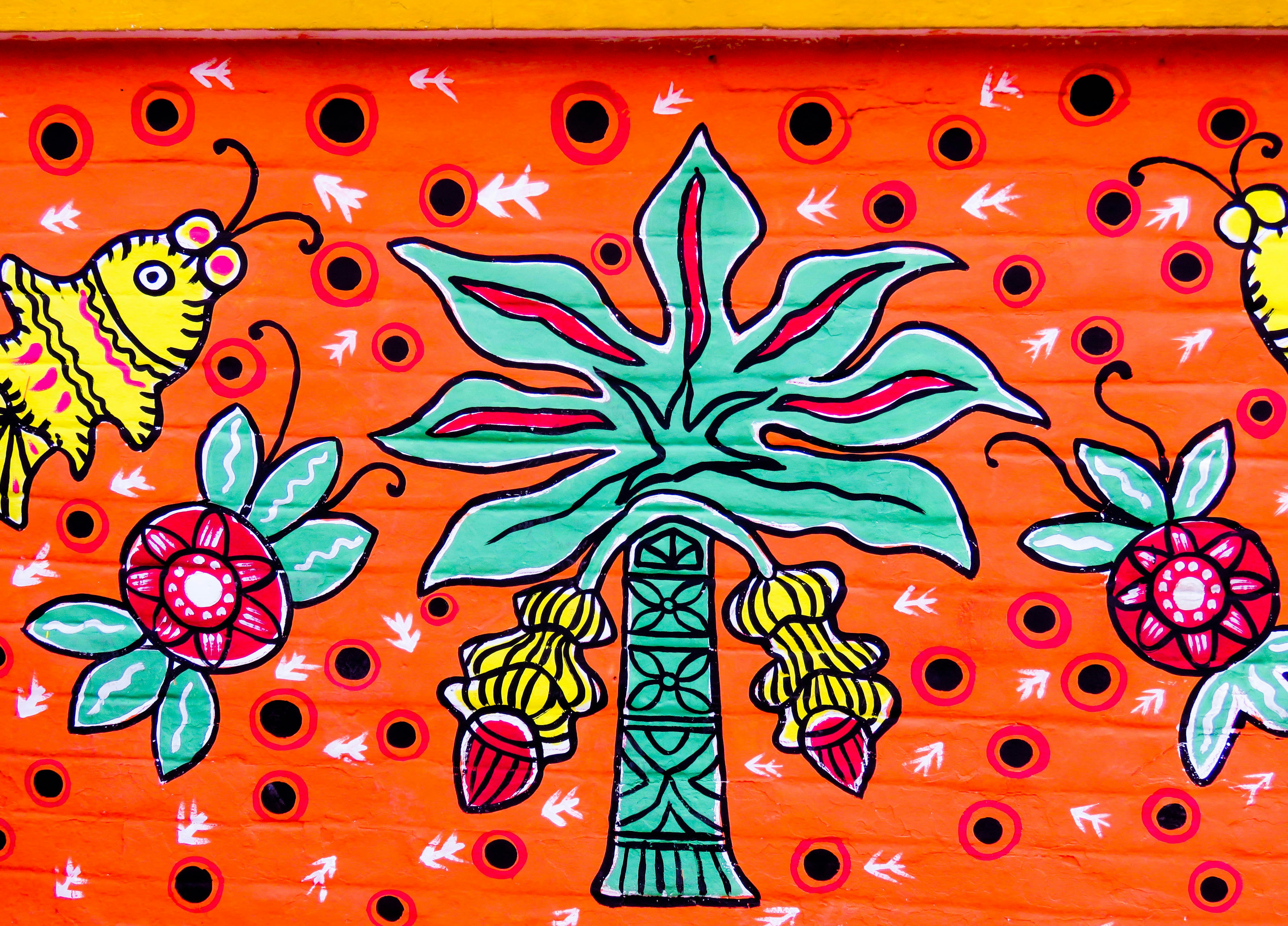 Vibrant Orange Mural with Palm and Banana Trees