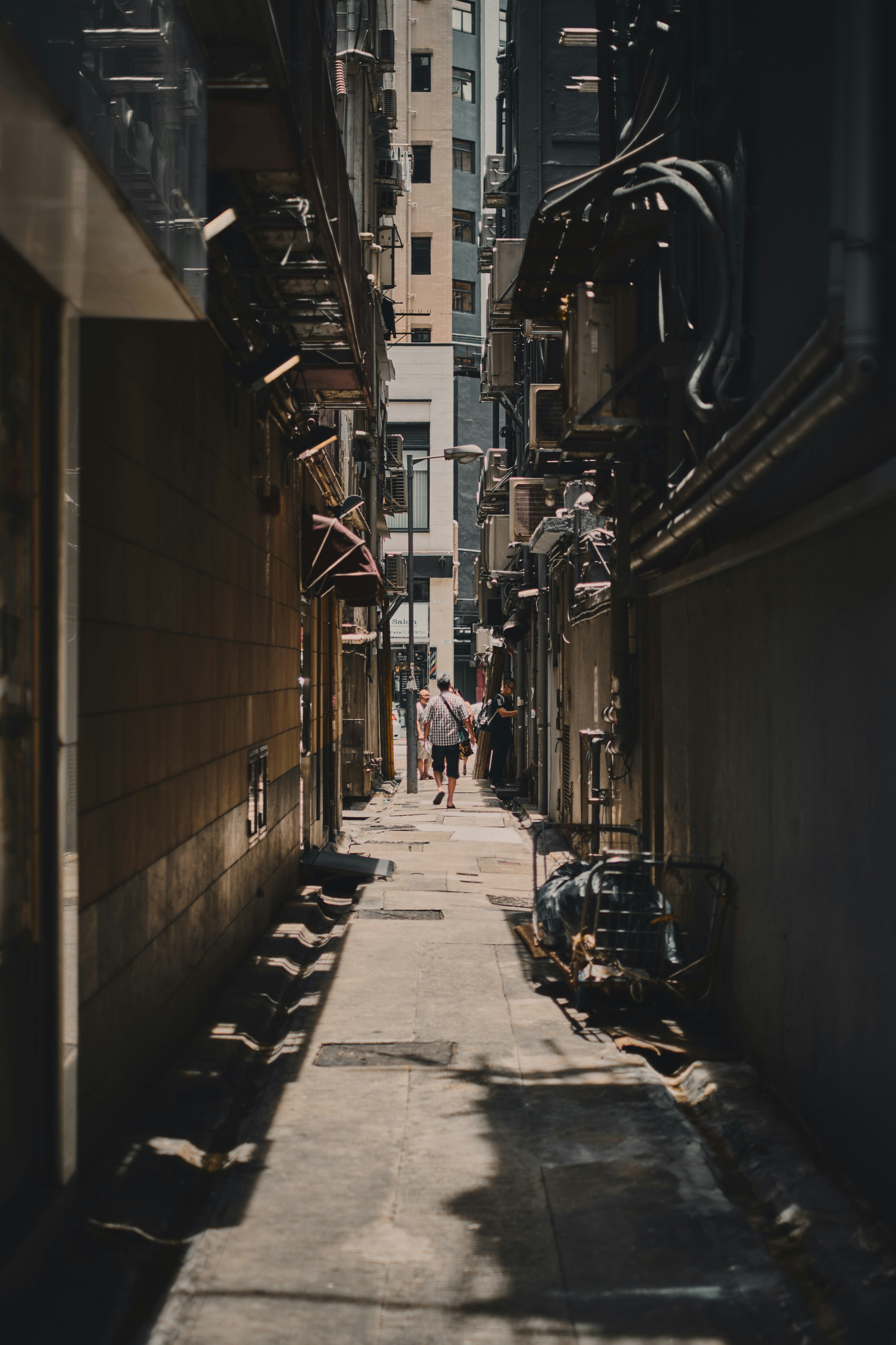 Alley photography of person walkway between building during daytime ...