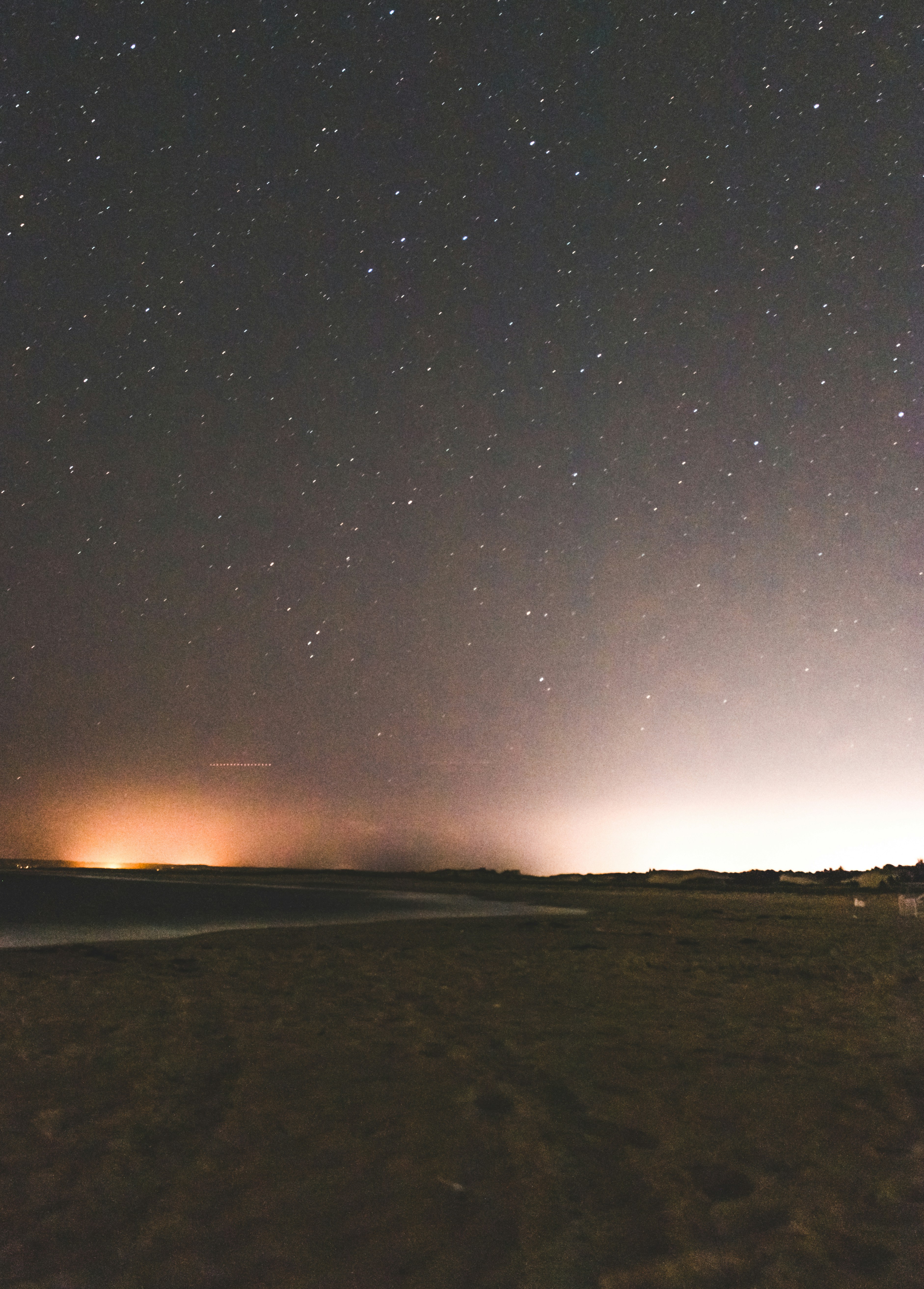 Distant Glow at the Edge of Night: Starfield Over a Silent Shore