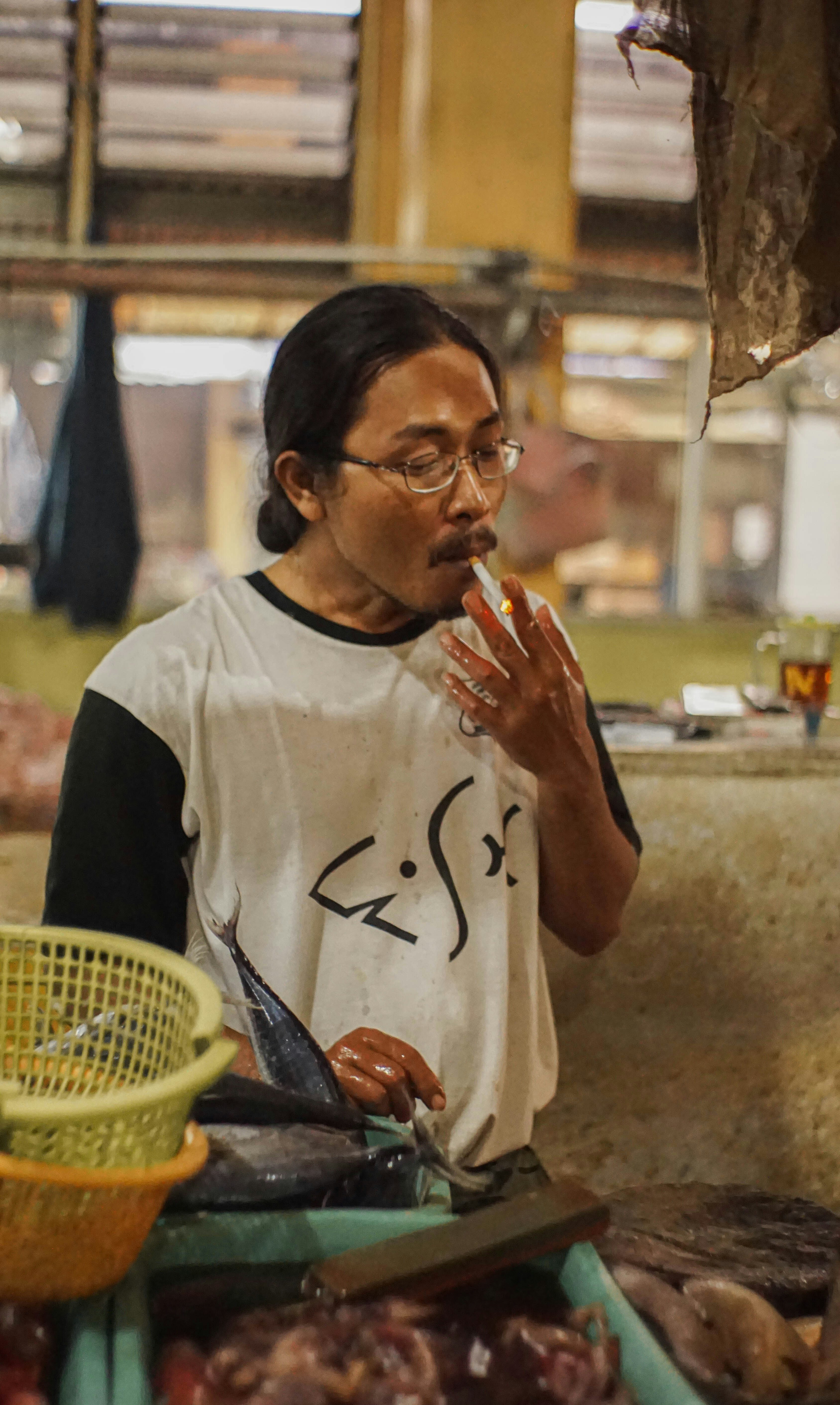 Midday Smoke Break in a Market Corridor