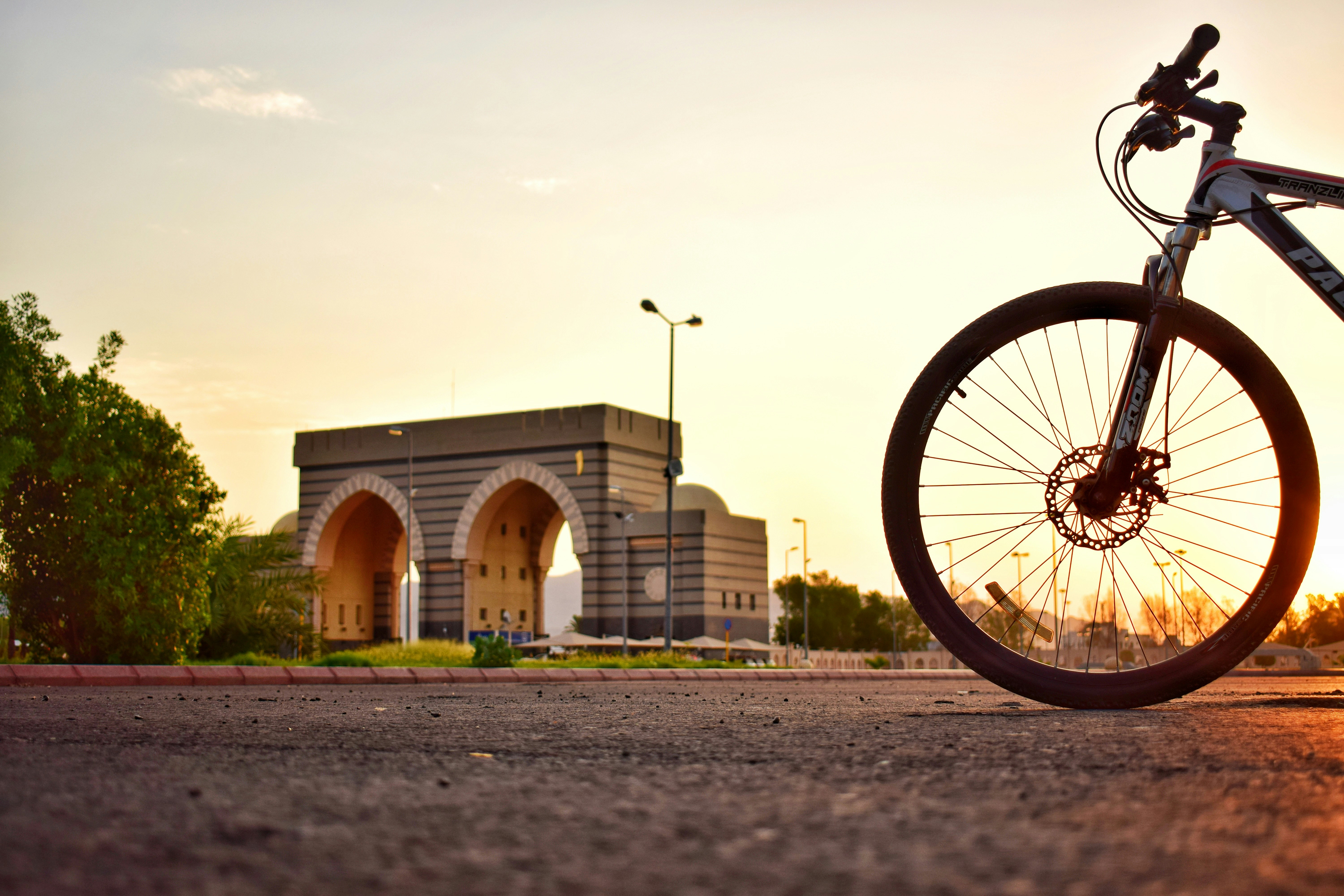 Sunset Drive-by: A Bicycle Framed by the Arch at Dusk