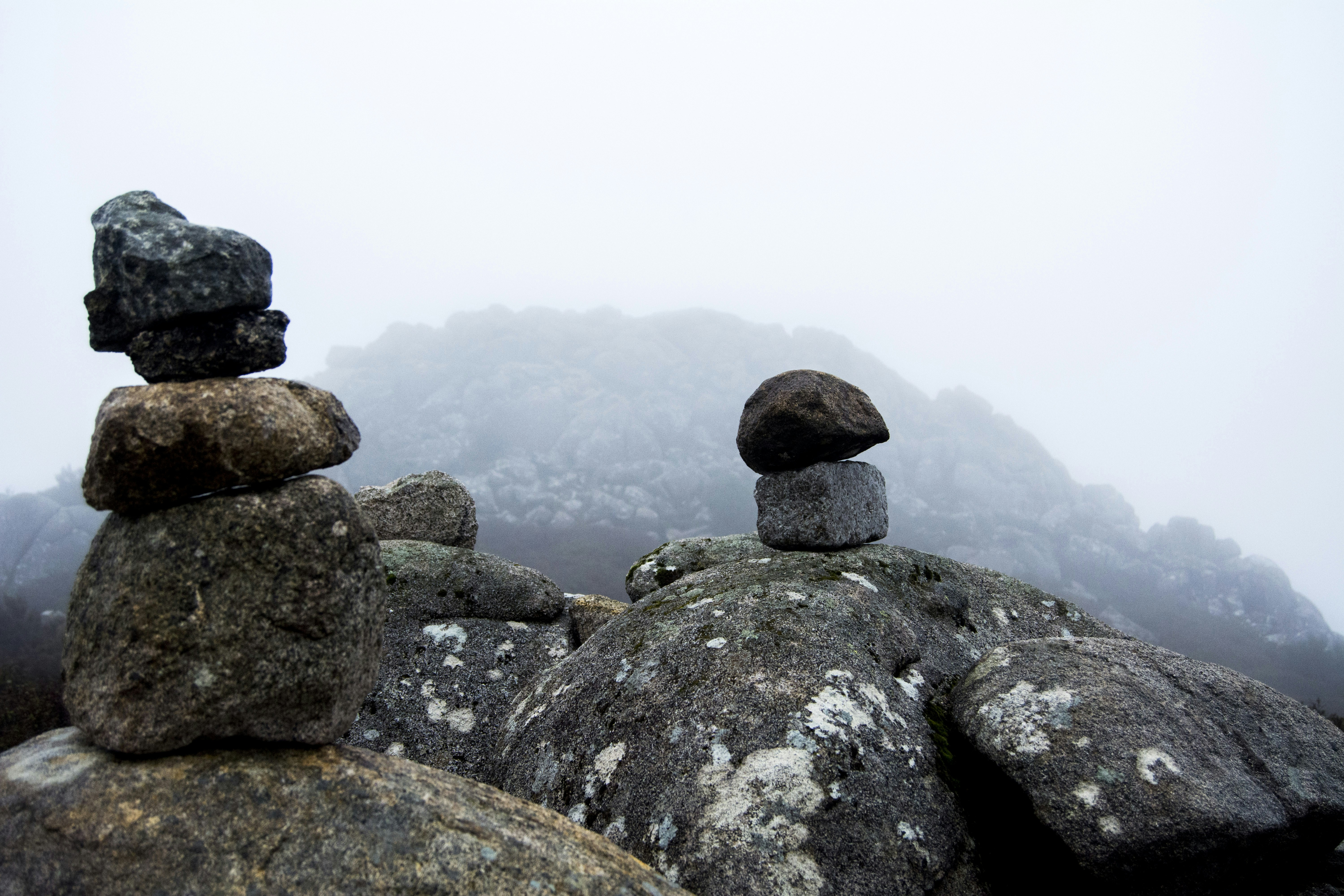 Several stone cairns on top of rocks photo – Free Blue Image on Unsplash