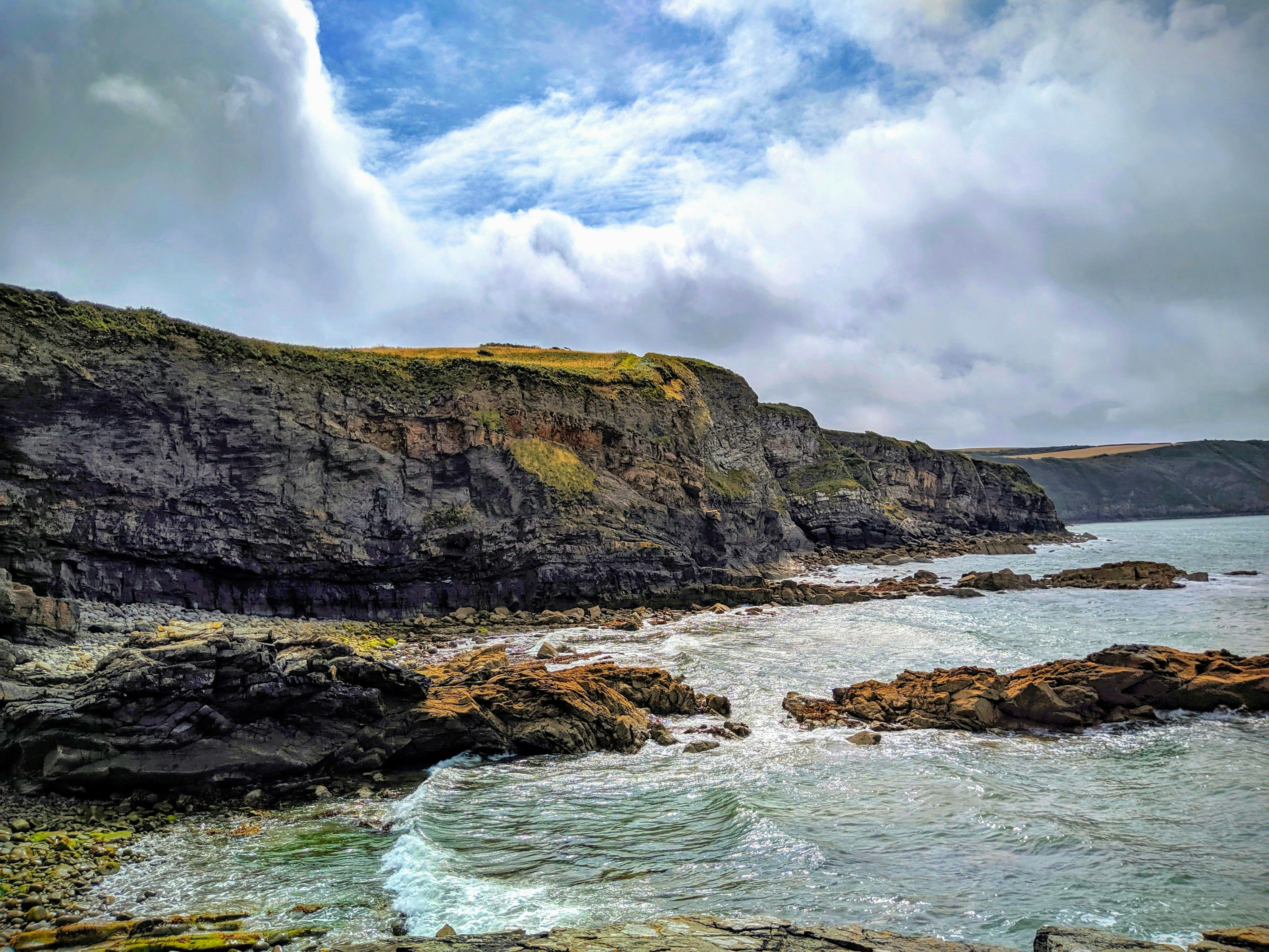Brown cliffs by a beach landscape photo – Free Sea Image on Unsplash