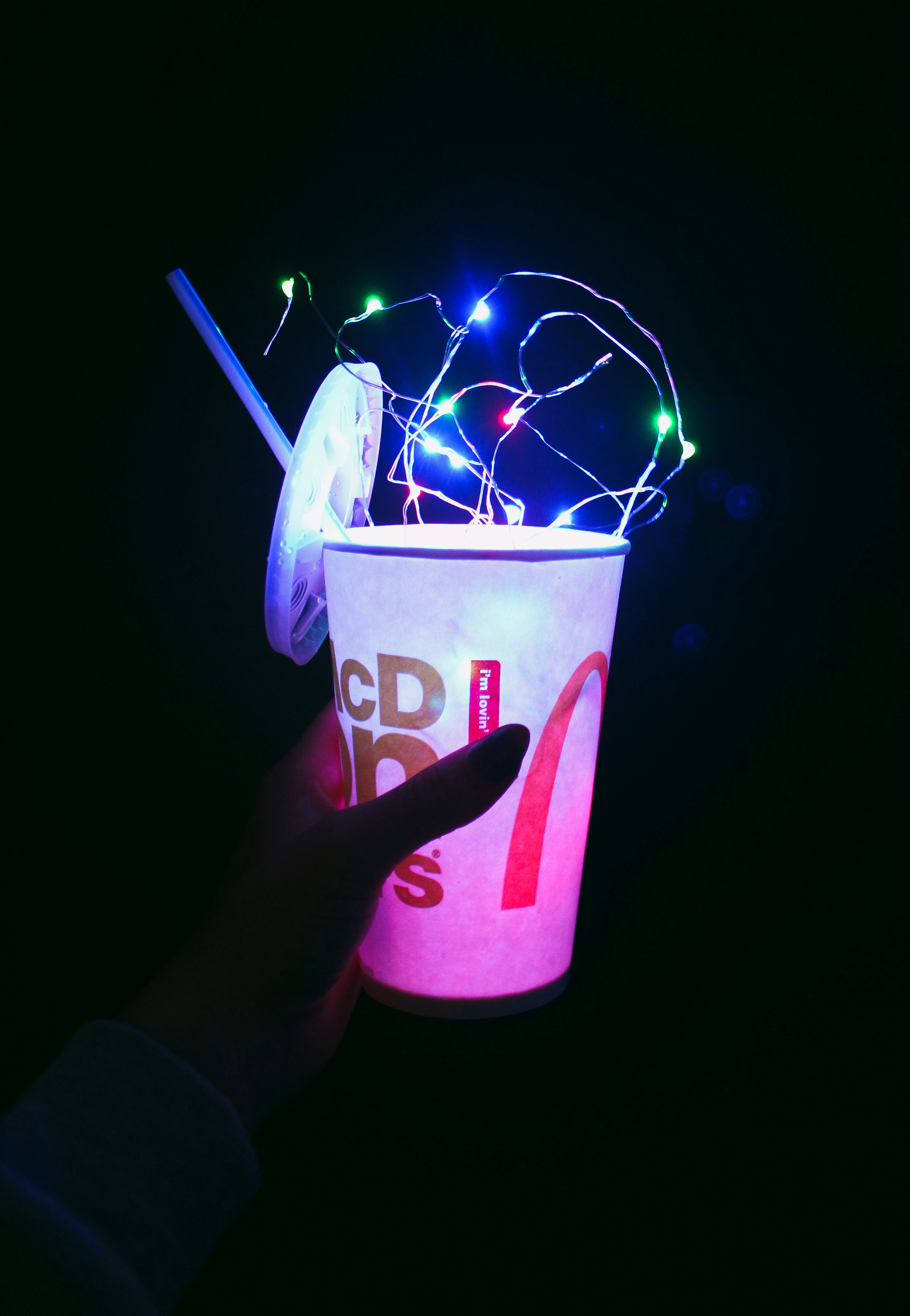 person holds McDonalds cup