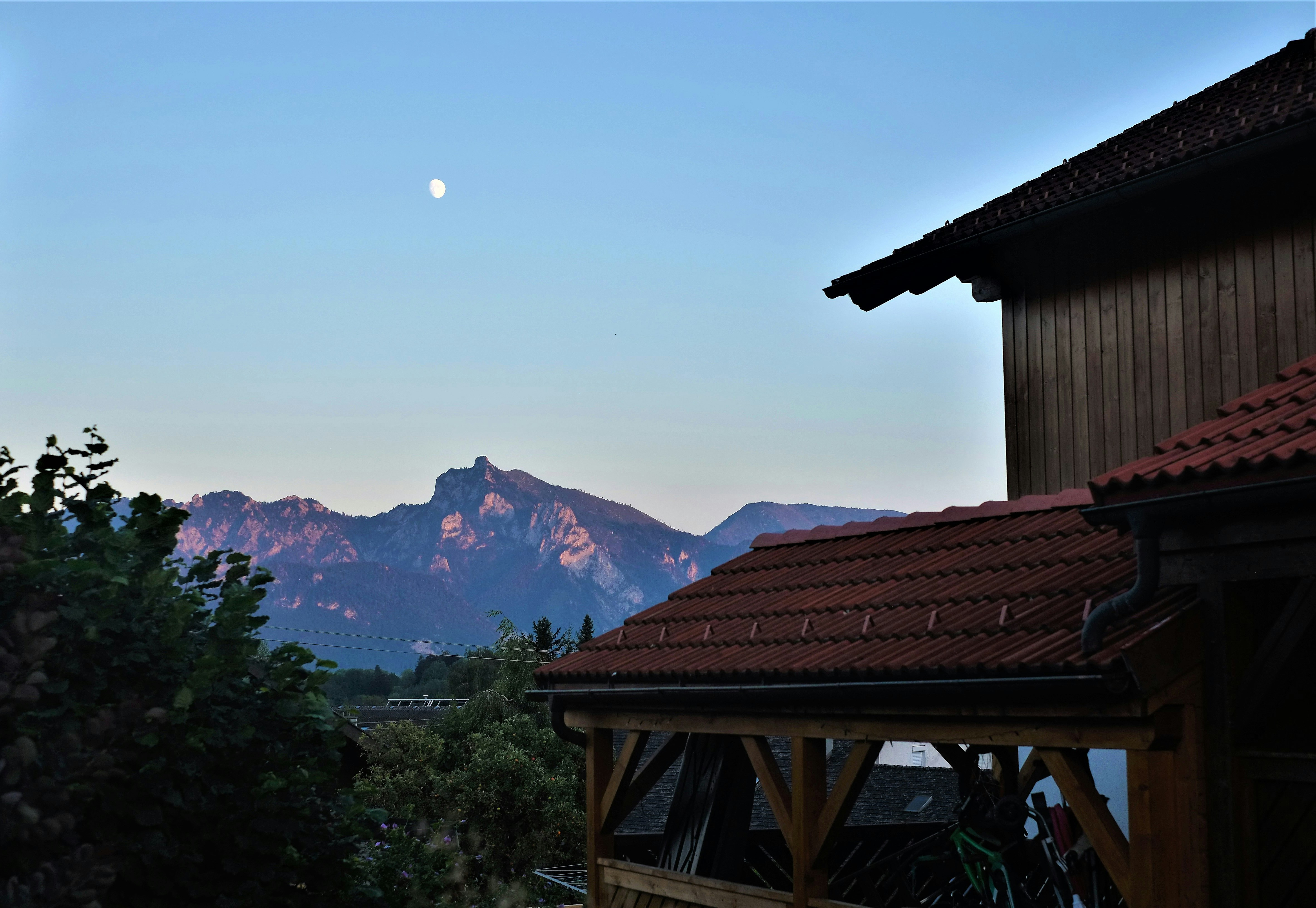 Moonrise Over a Timbered Balcony: Alpine Ridge at Dusk