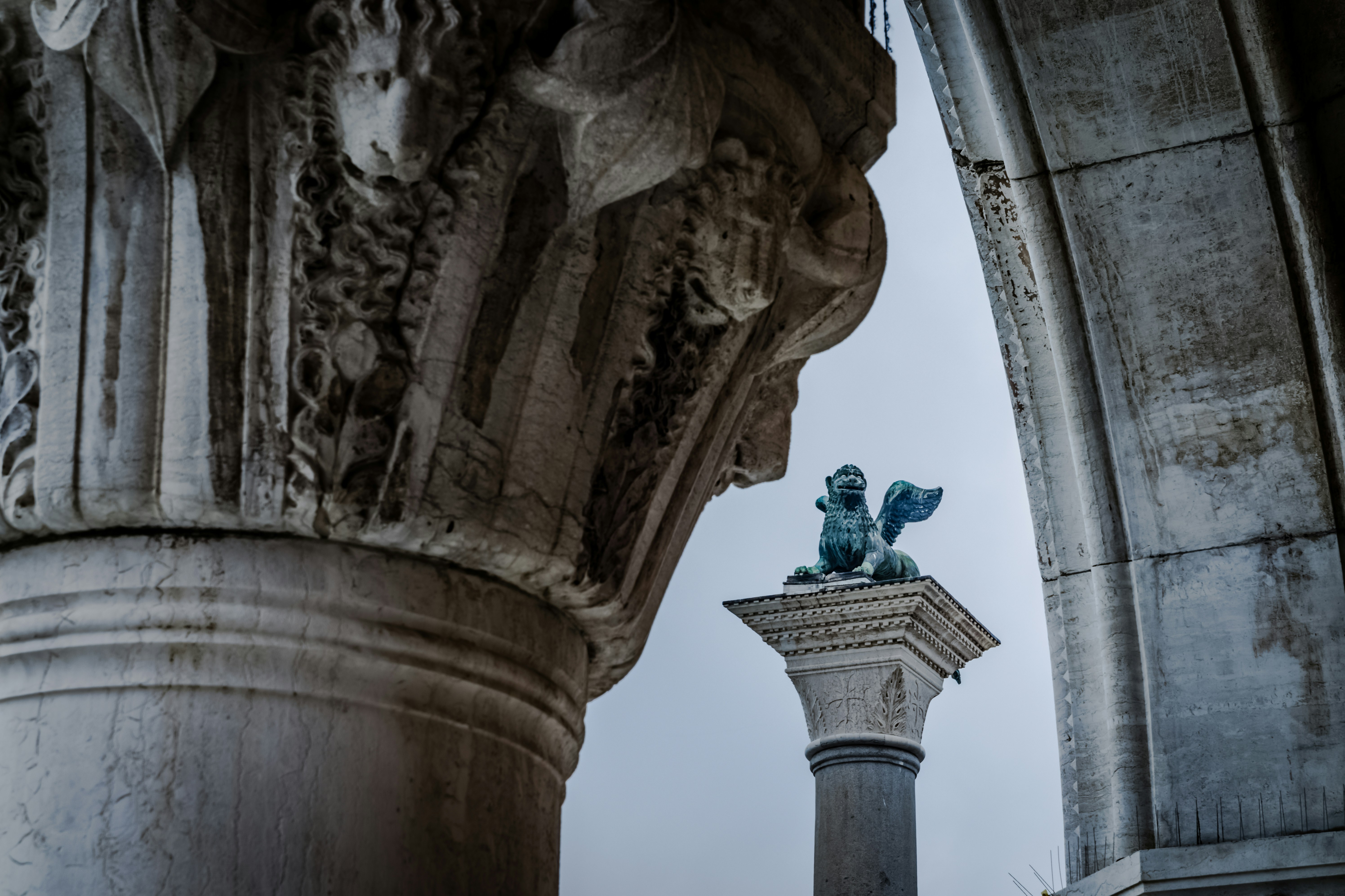 Winged Sentinel on a Distant Pedestal Framed by Monumental Arches