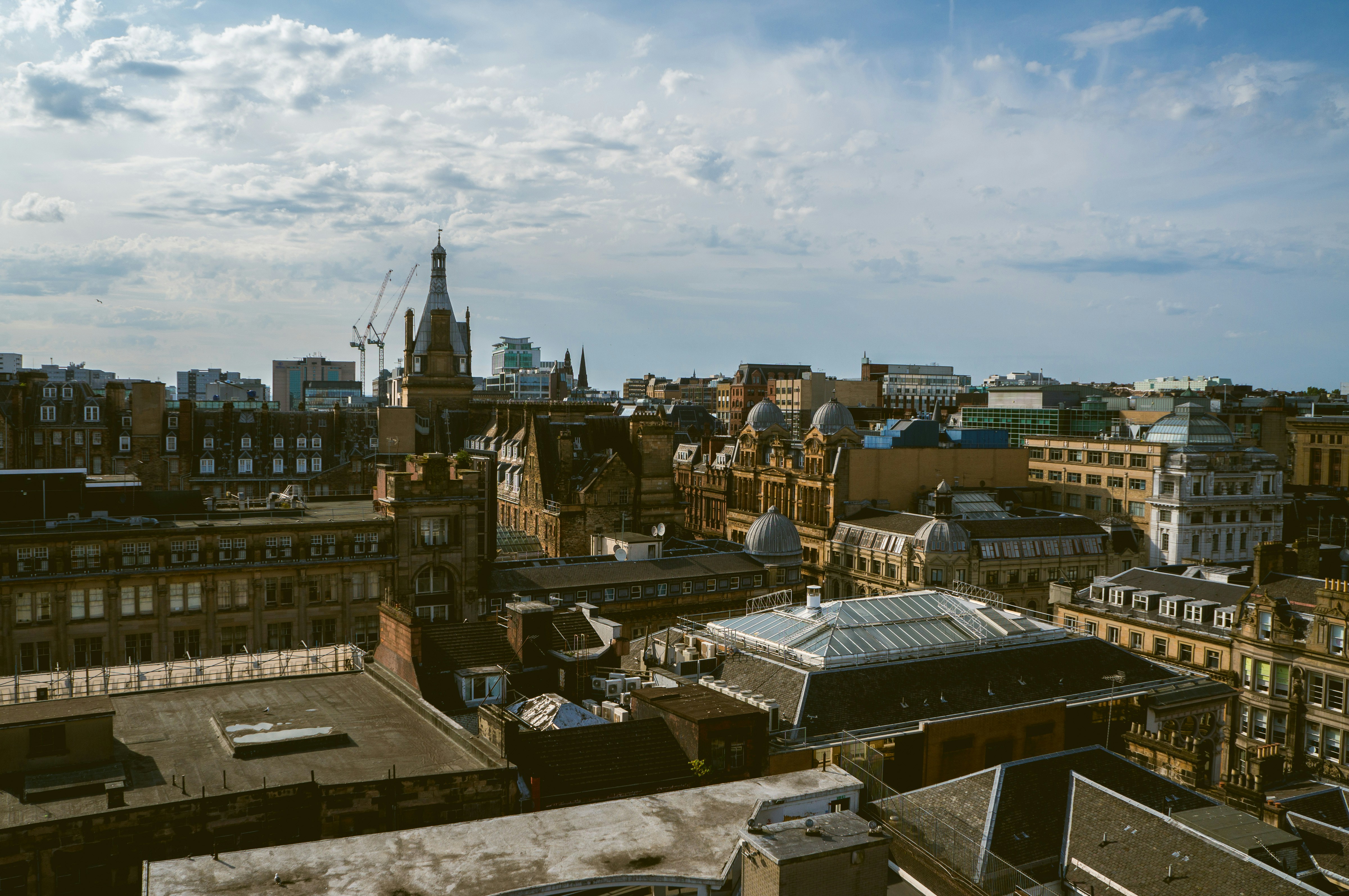 Panoramic view of Glasgow’s diverse architecture under a clear blue sky.